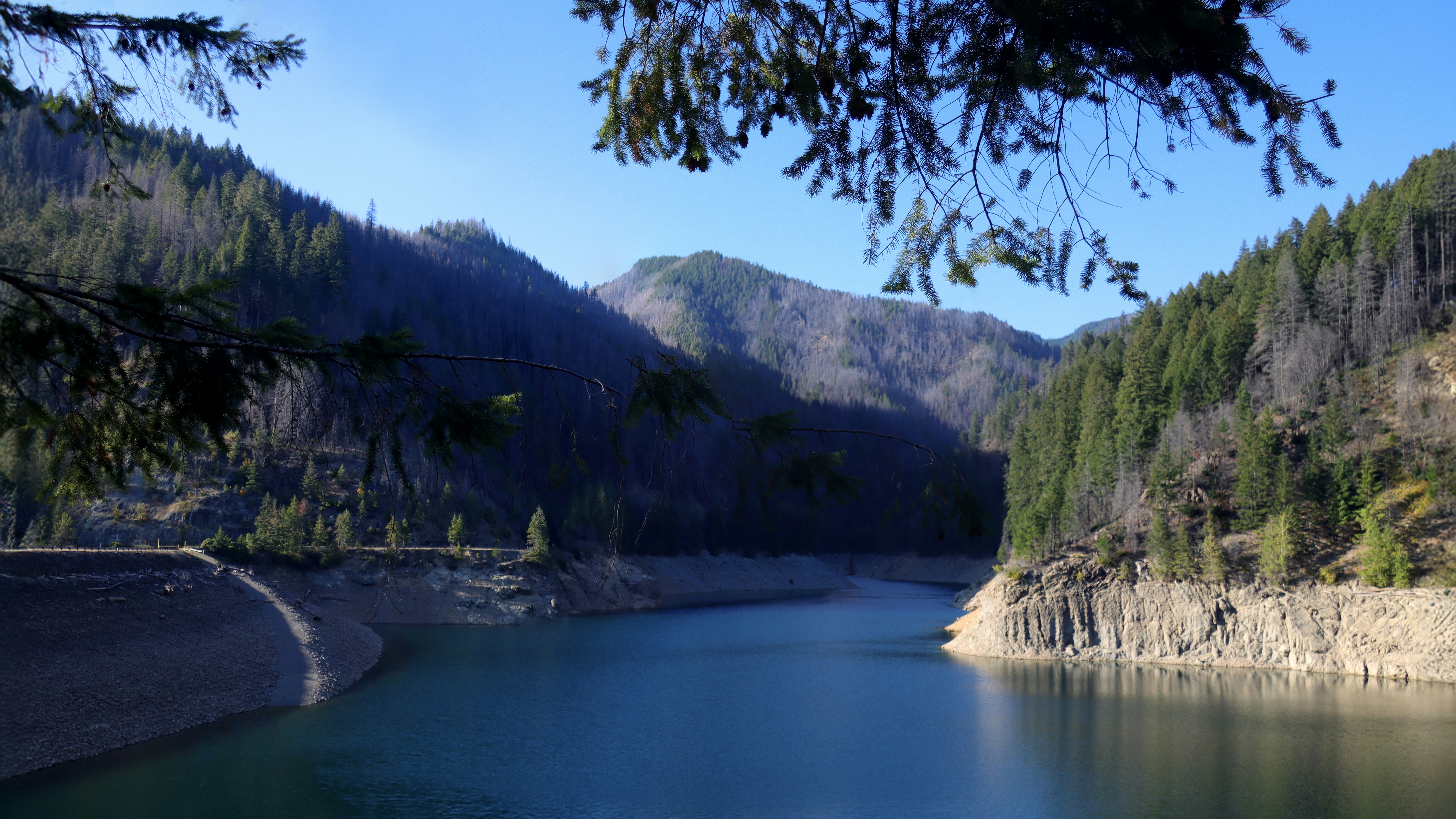 Serene Reservoir Between Forested Ridges at Peak Afternoon