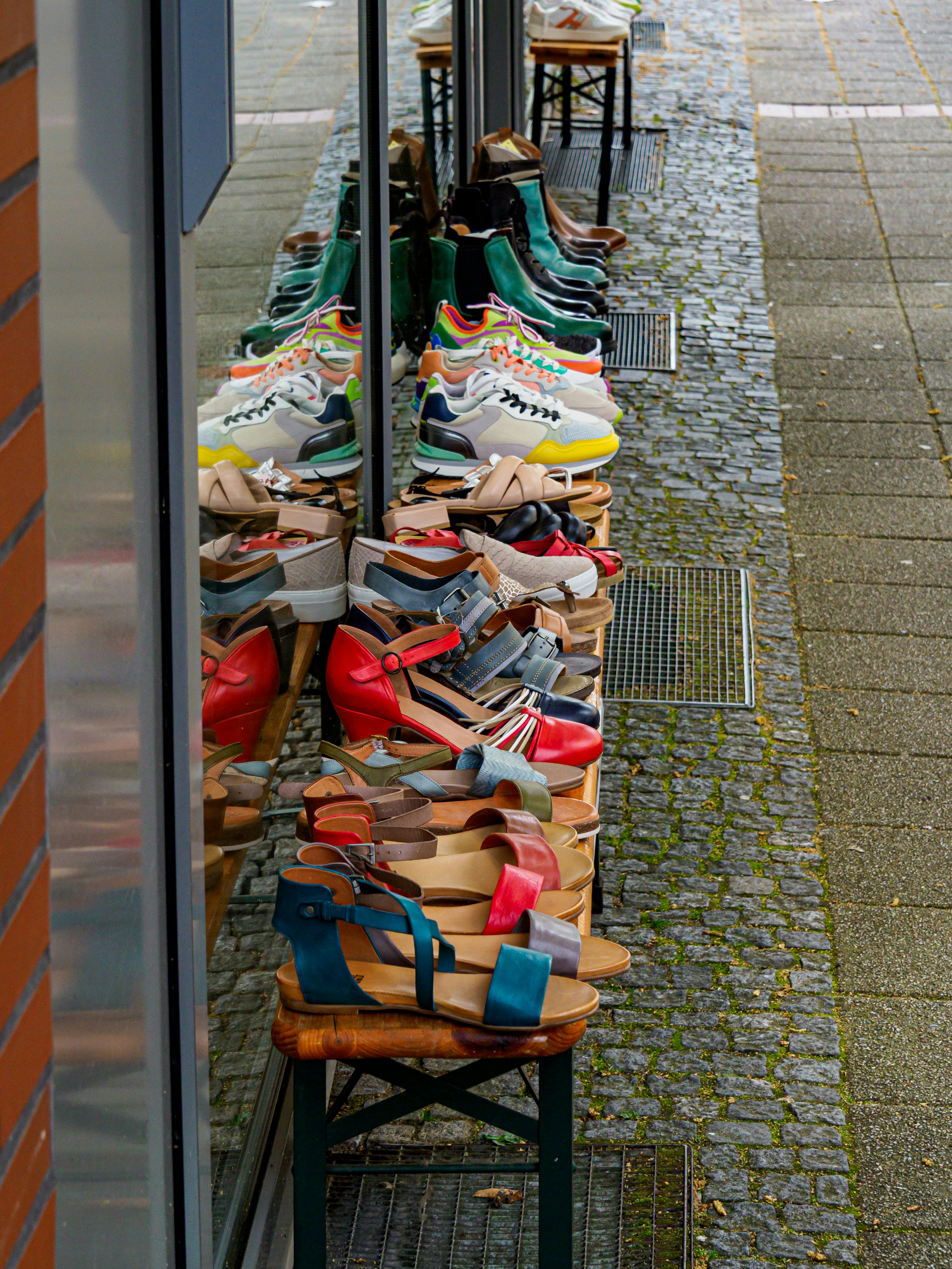 Row of Colorful Shoes on a Narrow Display Shelf