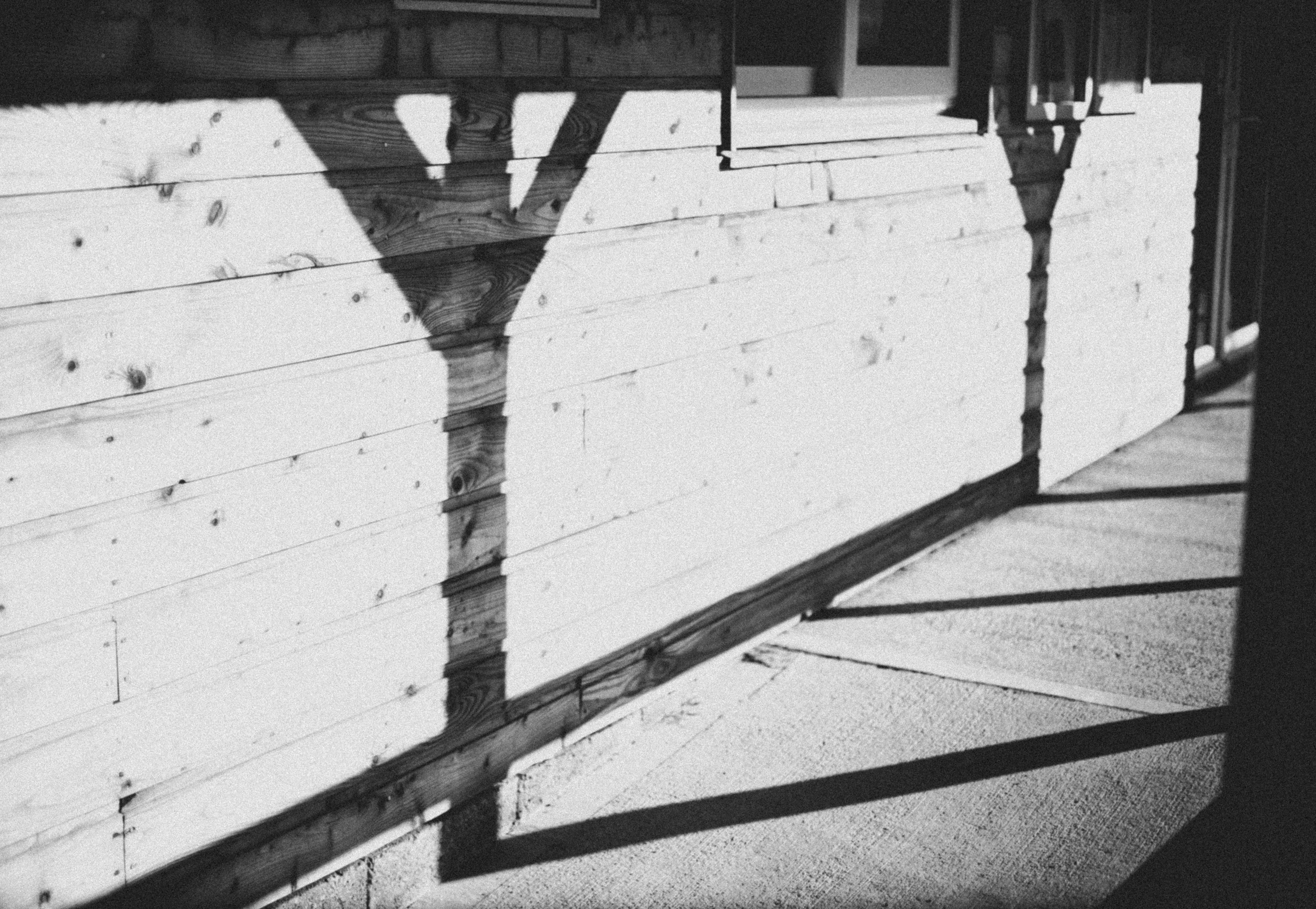 Shaded Crosswalk Shadows on Weathered Wood Wall