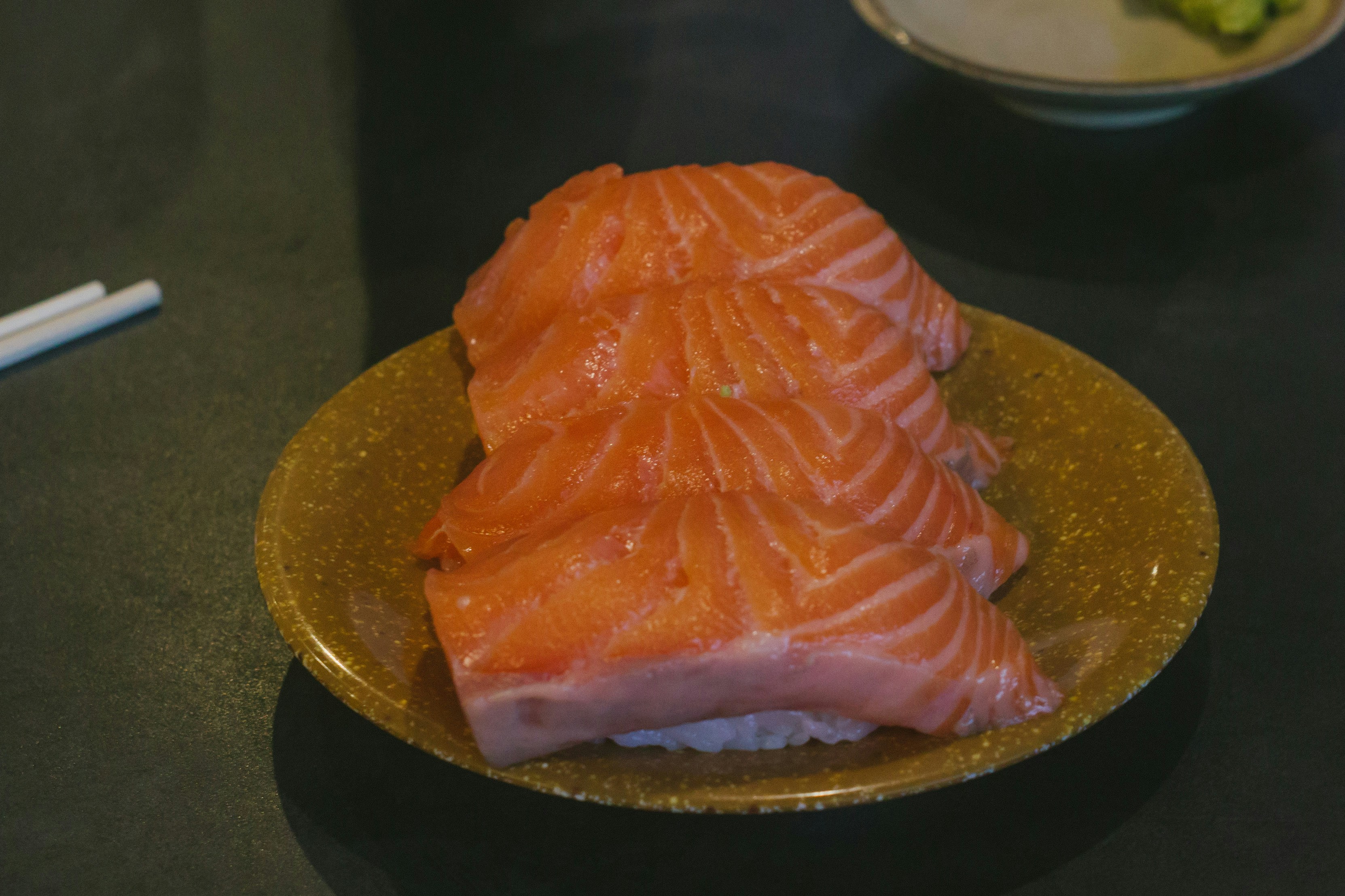 Sliced Sashimi Fanned Like Petals on a Golden Plate