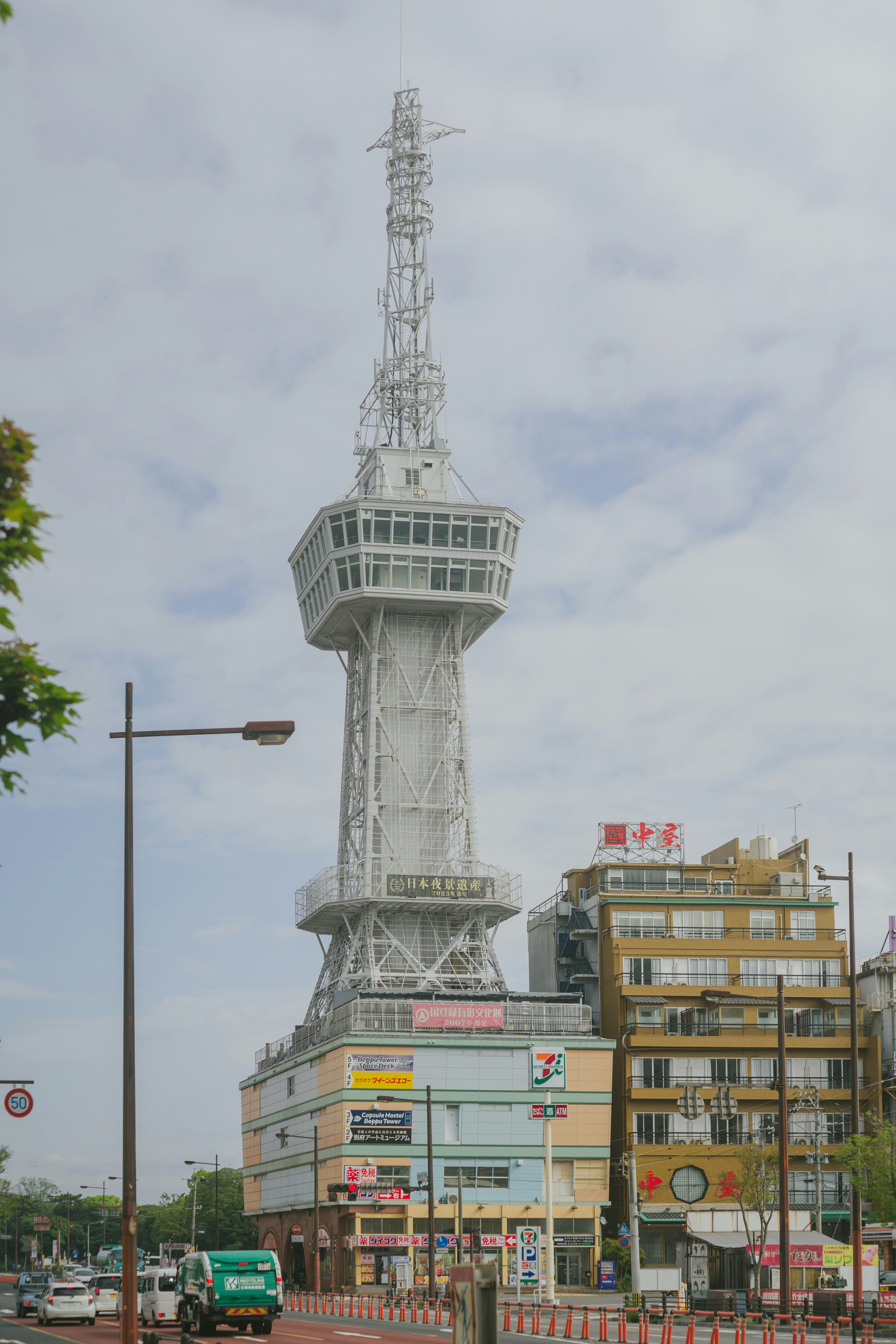 Towering Transit: A City Landmark Rises Over a Street of Shops