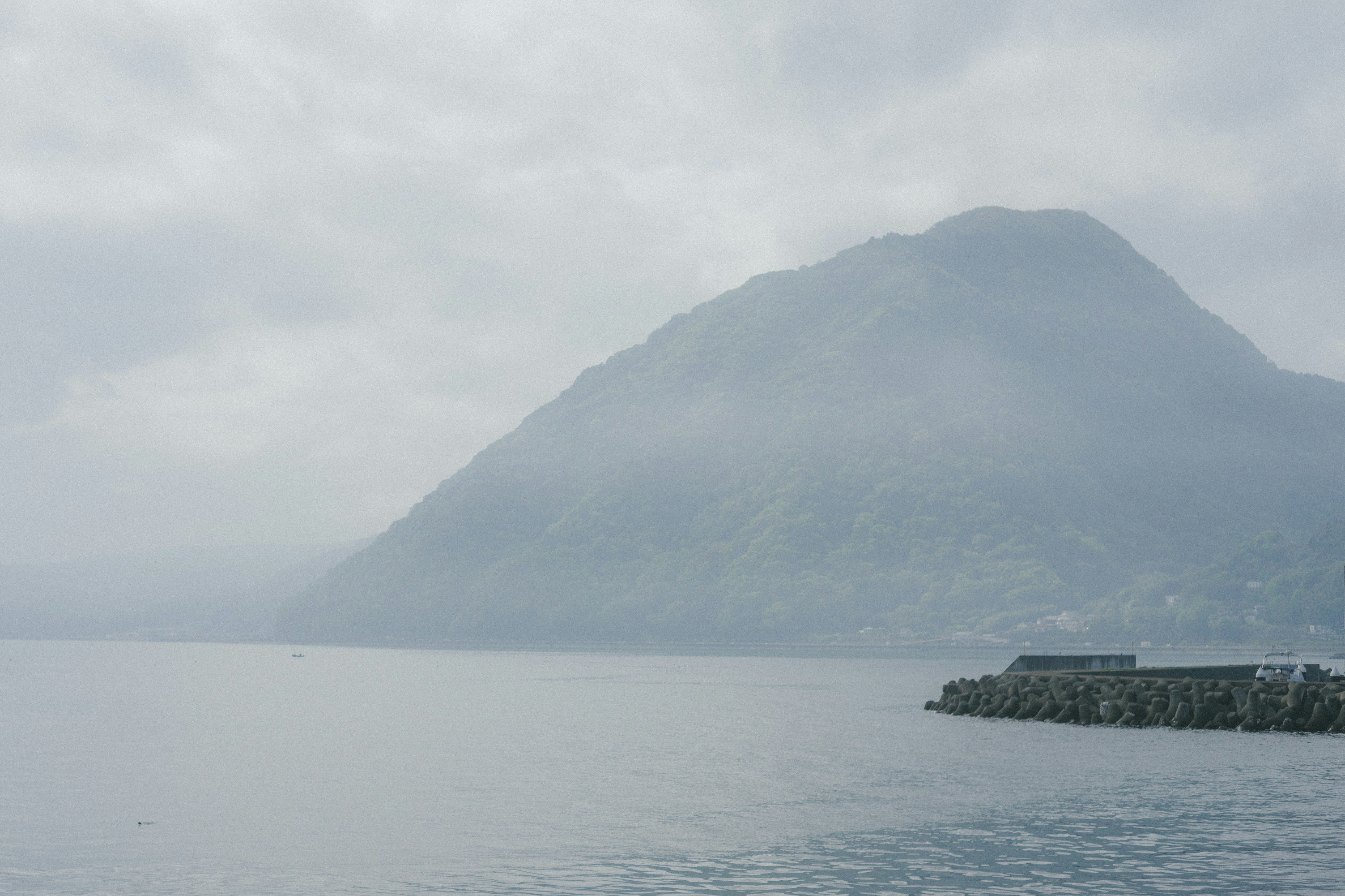 Mist-Laced Mountain Embracing a Quiet Inland Sea