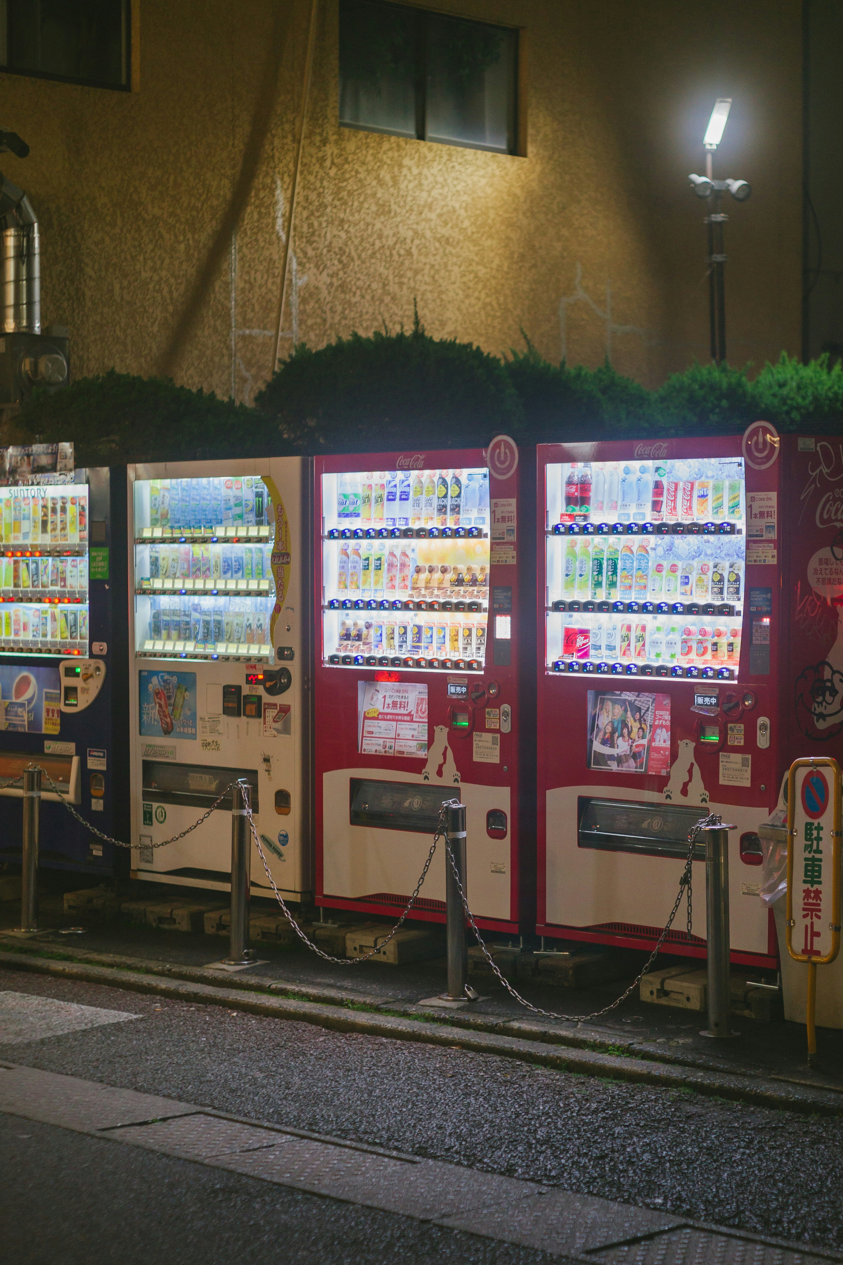 Night Vending Row: Neon Light and Vending Machines on a Quiet Street