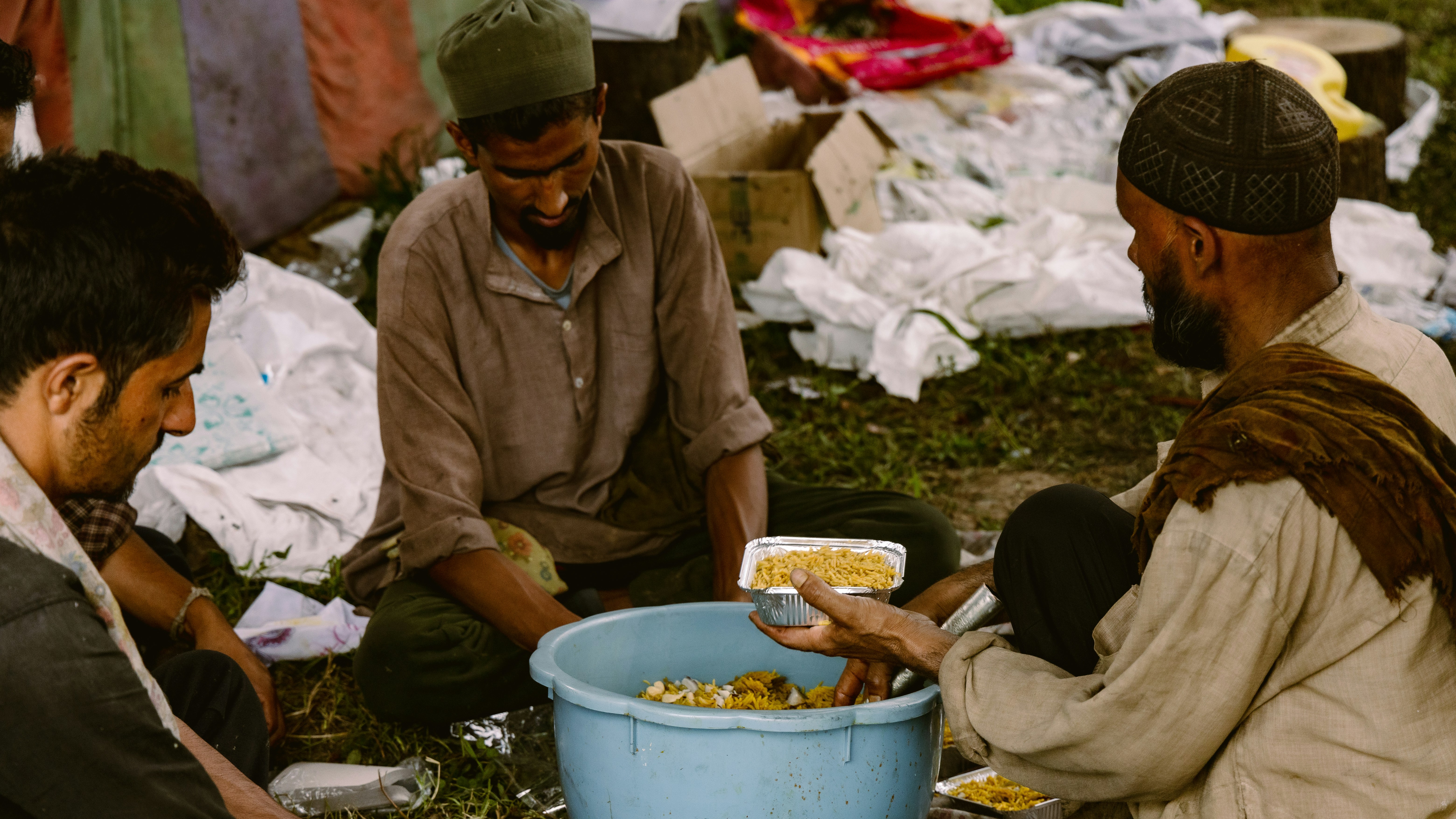 Gathered Round: Shared Meal Beneath a Patchwork Tent