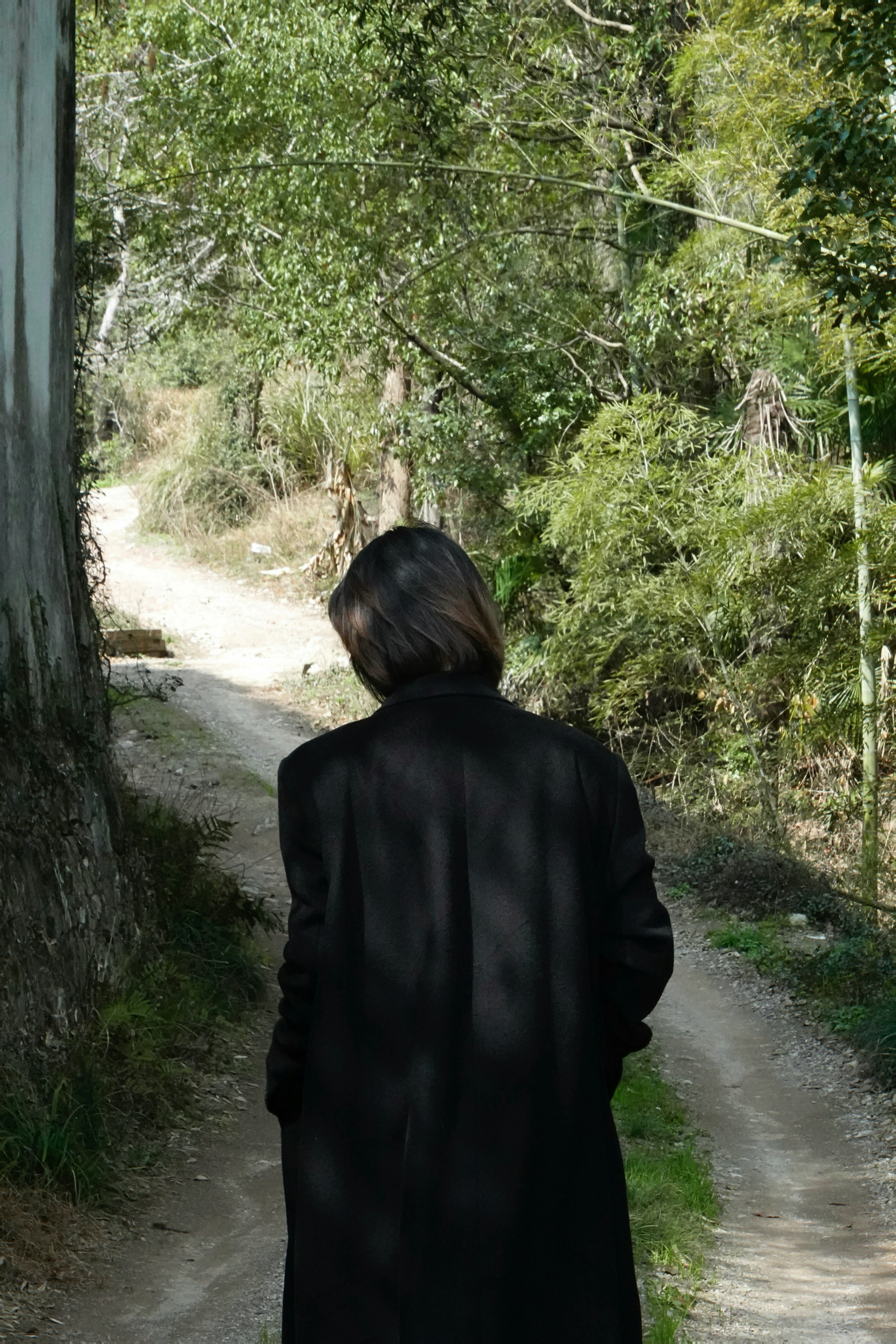 Midway Down a Shaded Trail: Portrait in a Black Coat