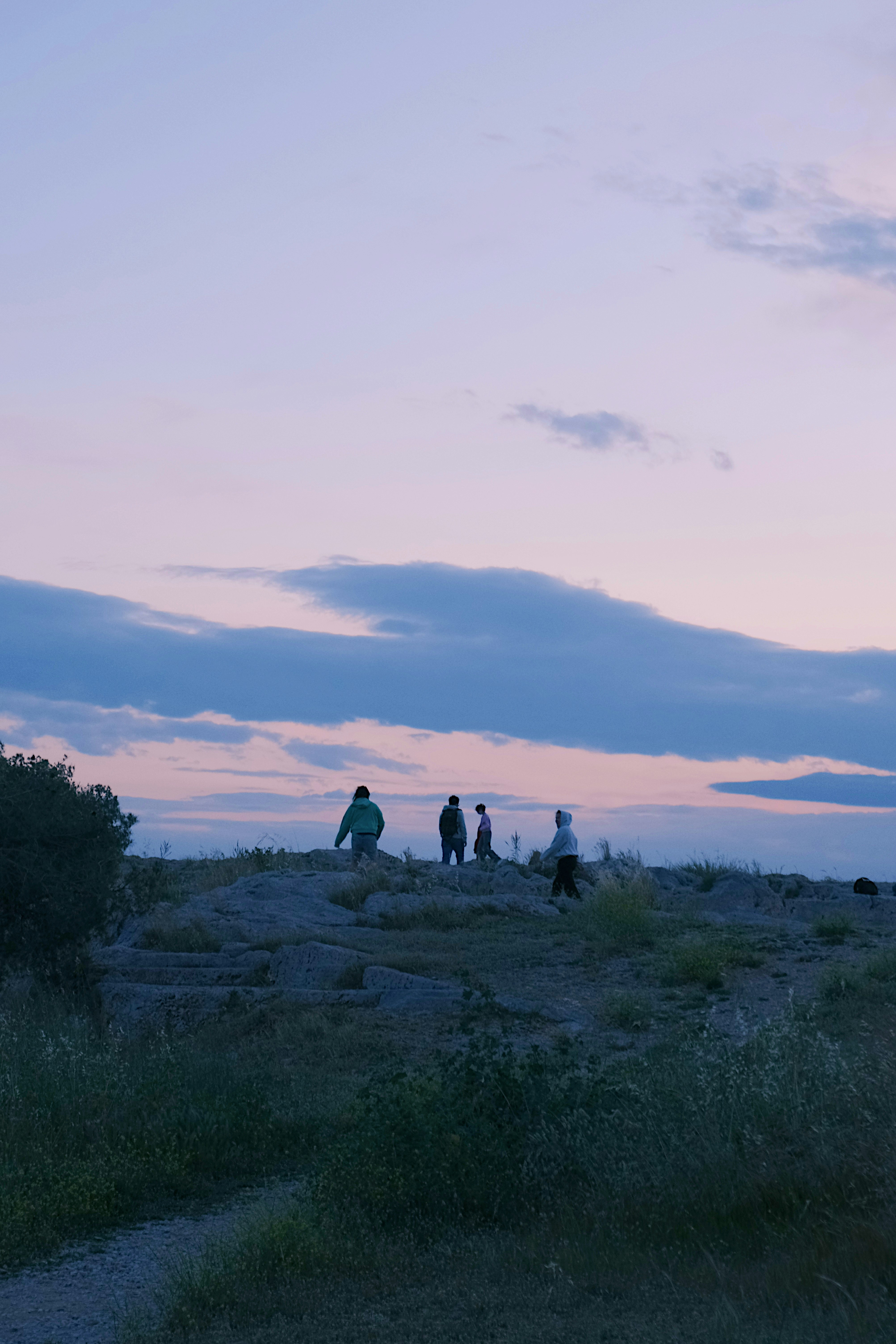 Distant Silhouette: Five Figures on a Dusk-Dusted Summit