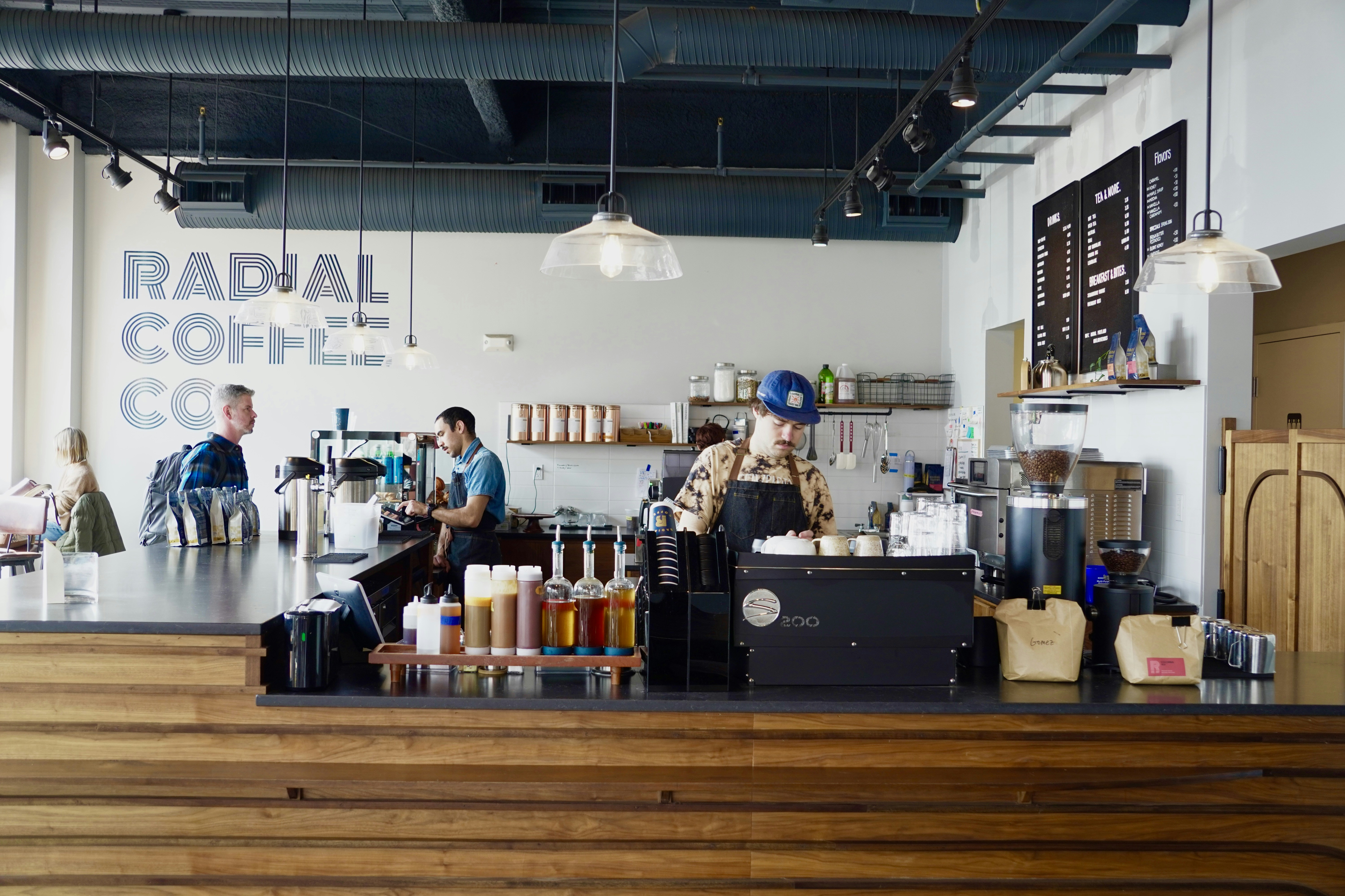 Espresso Run: Barista Behind the Counter at a Light-filled Cafe
