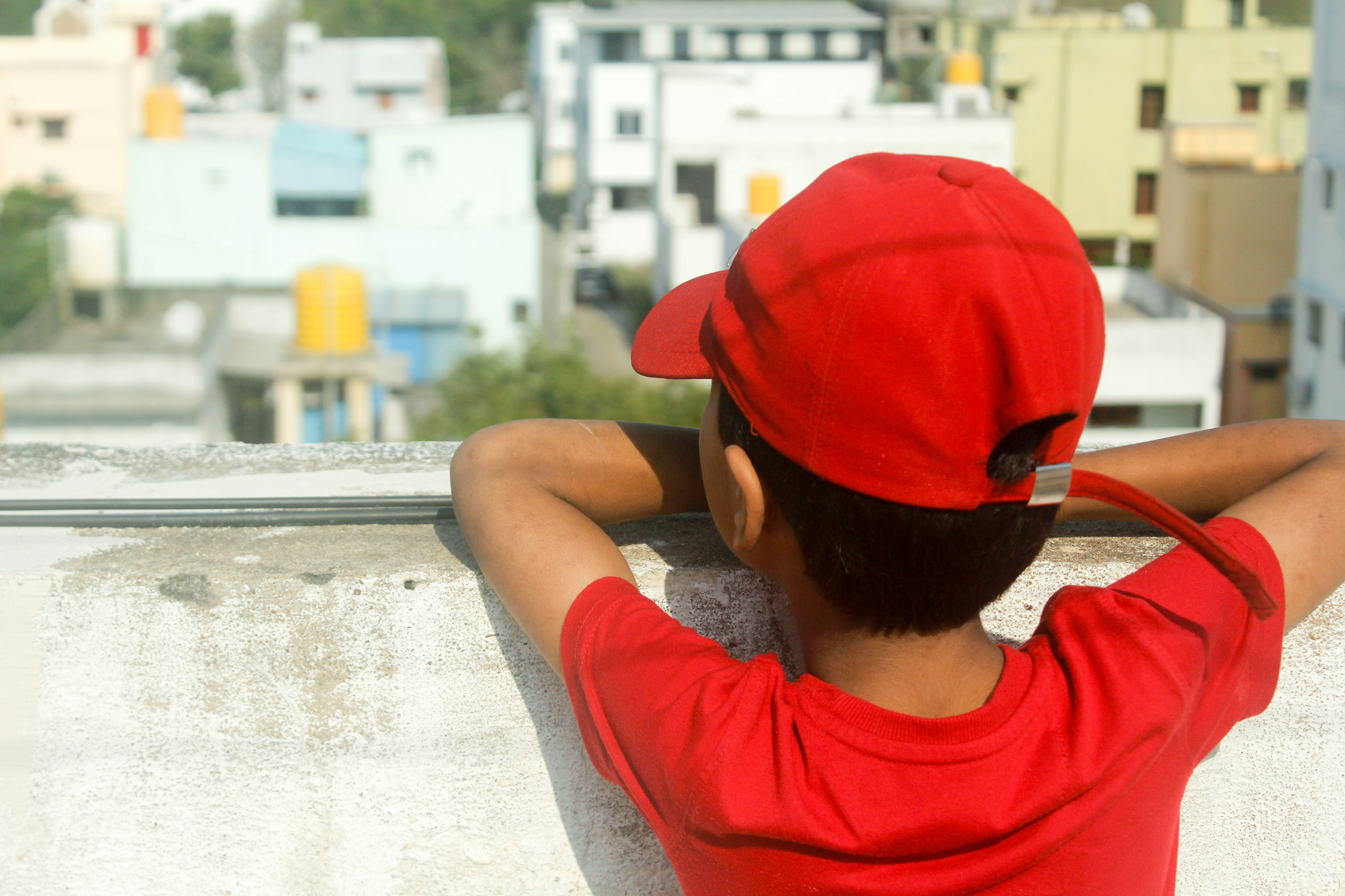 Red Cap, City Skyline: A Rooftop Gaze