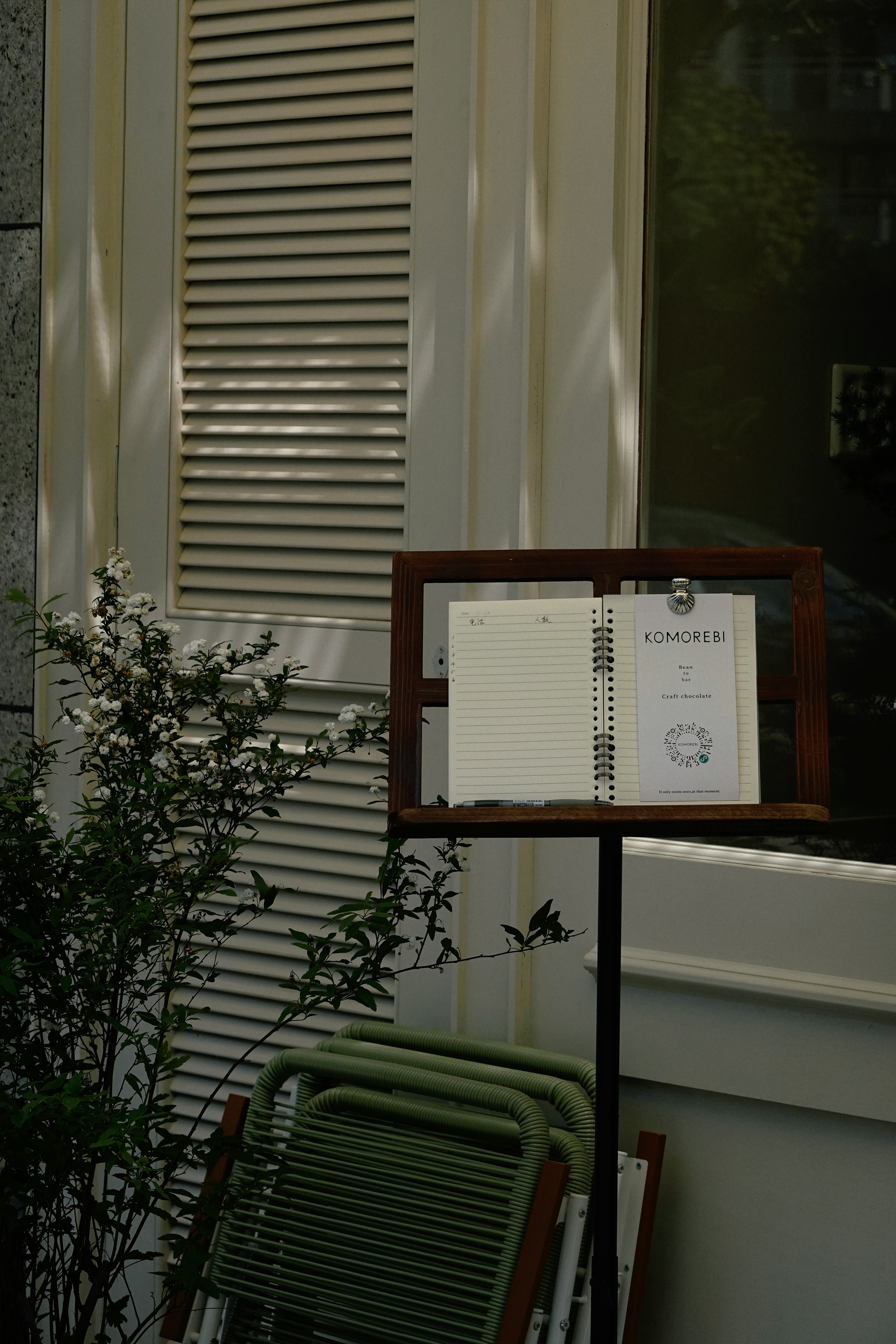 Music Stand Amid Quiet Facade: A Street-Quiet Sheet Moment