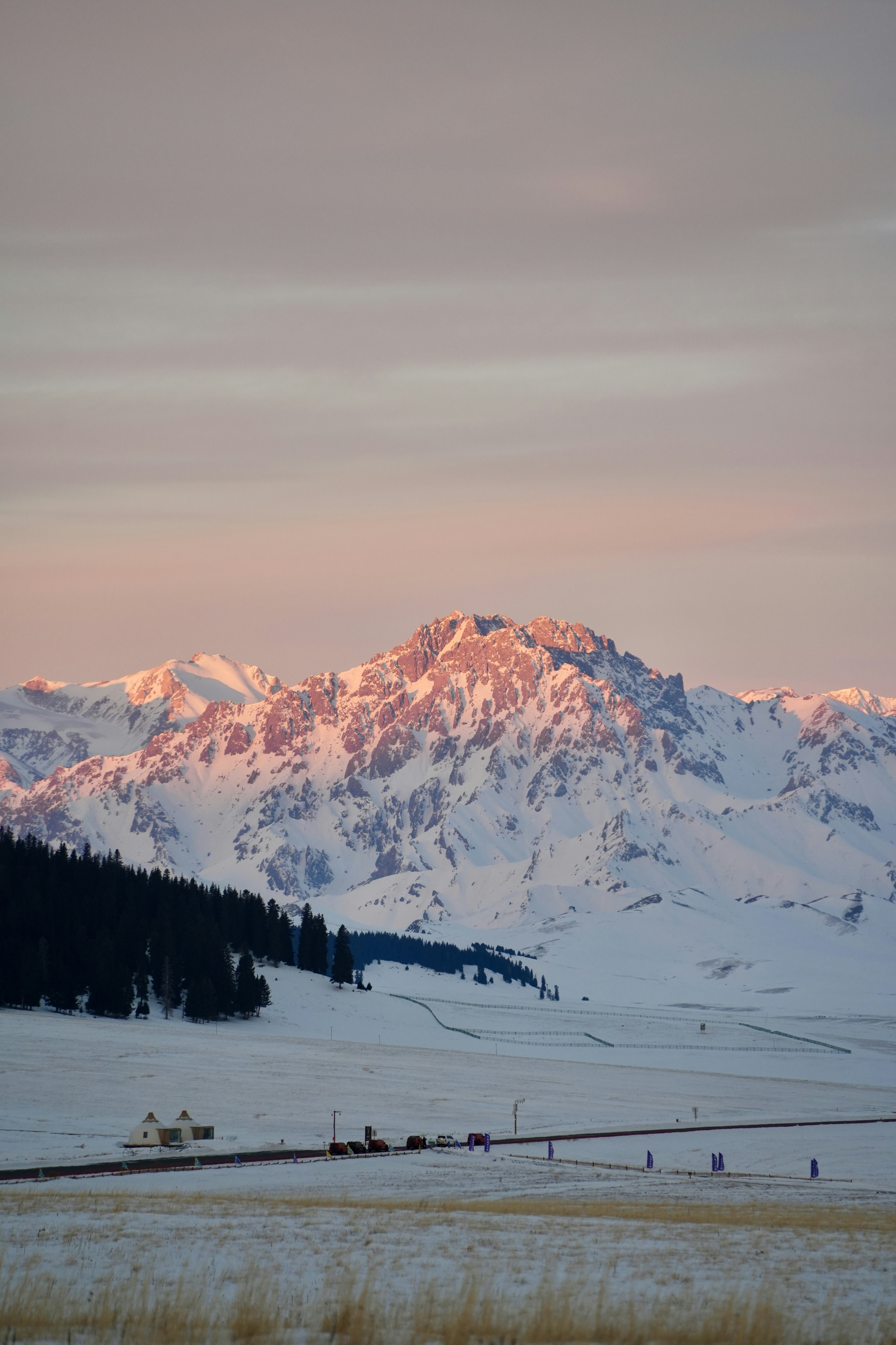 Crimson Crest: Snow-Capped Peaks at Dusk