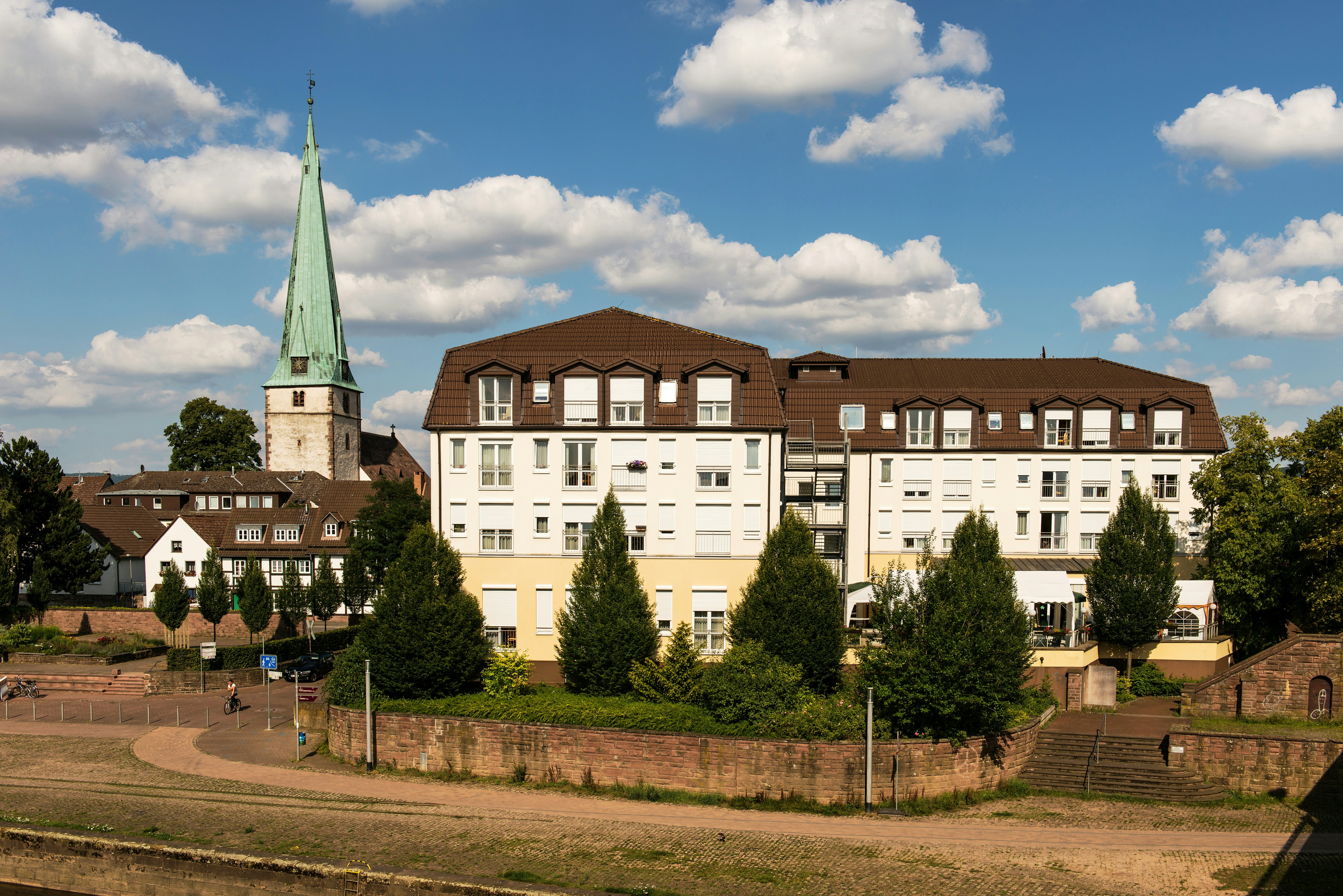 Village Crest Overlook: A Sunlit Row of Homes and a Green Steeple