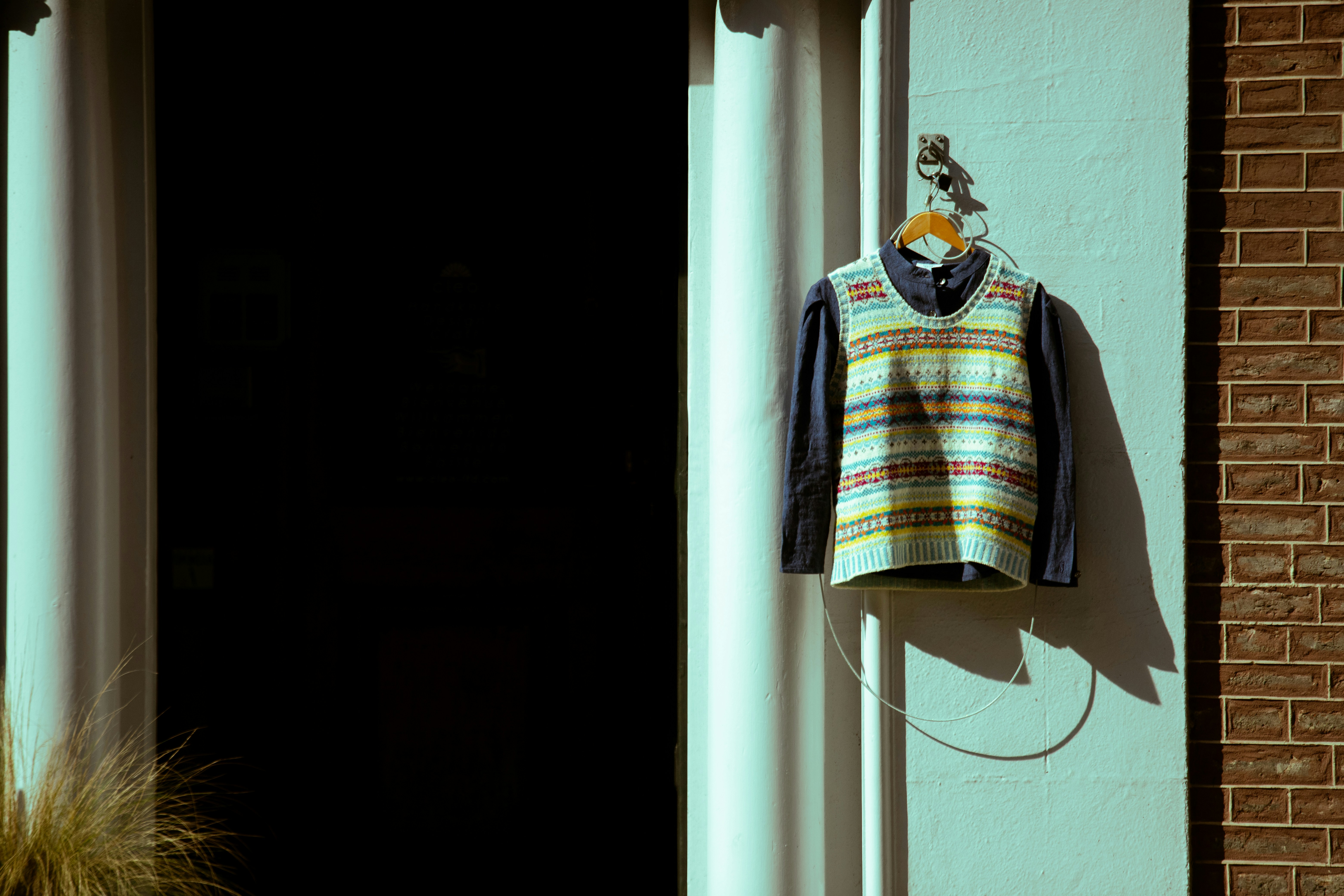 Woven Vest on a Weathered Wall: A Quiet Gallery of Texture