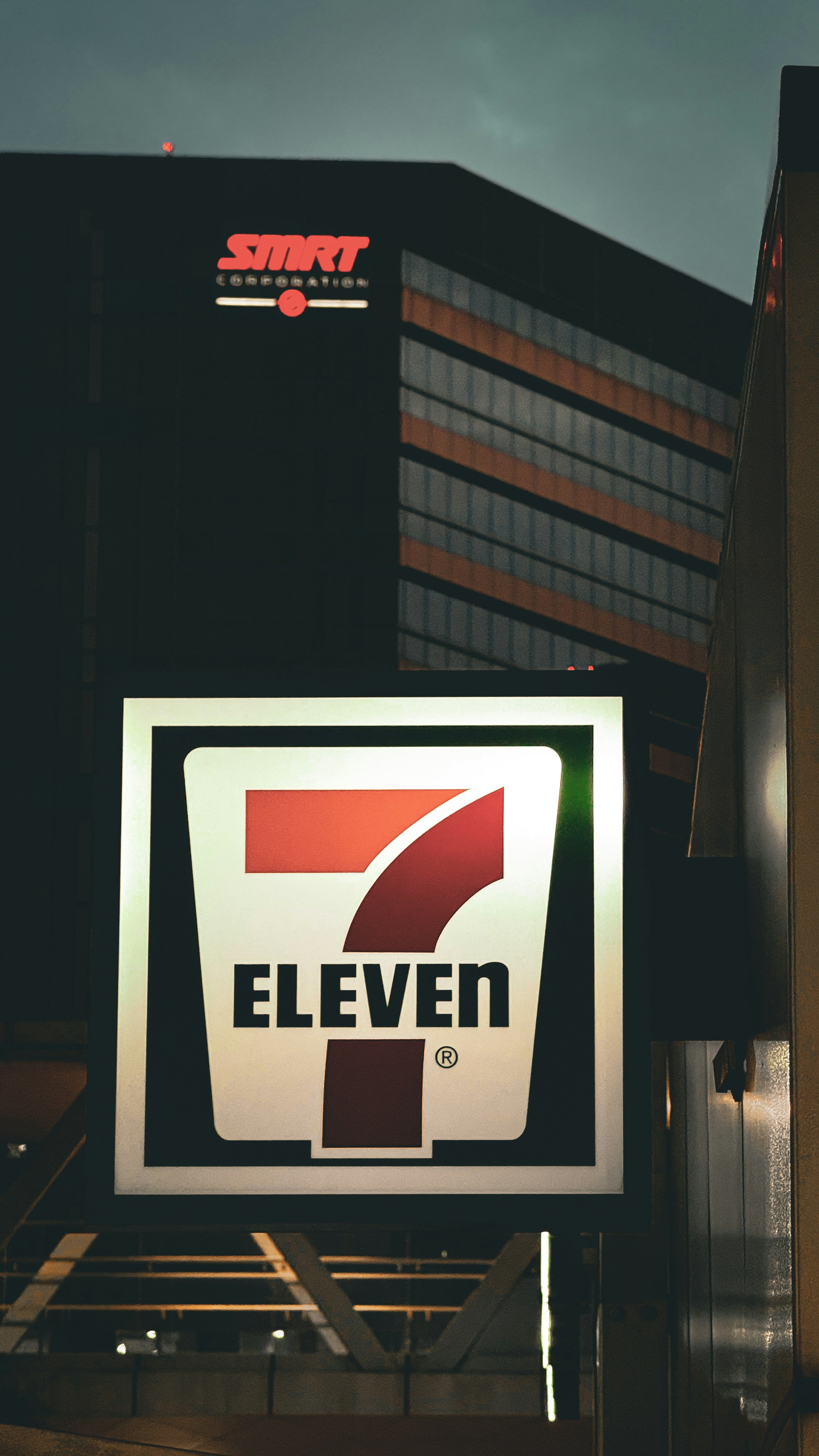 Neon Seven-Eleven Sign Illuminates a Quiet City Corner