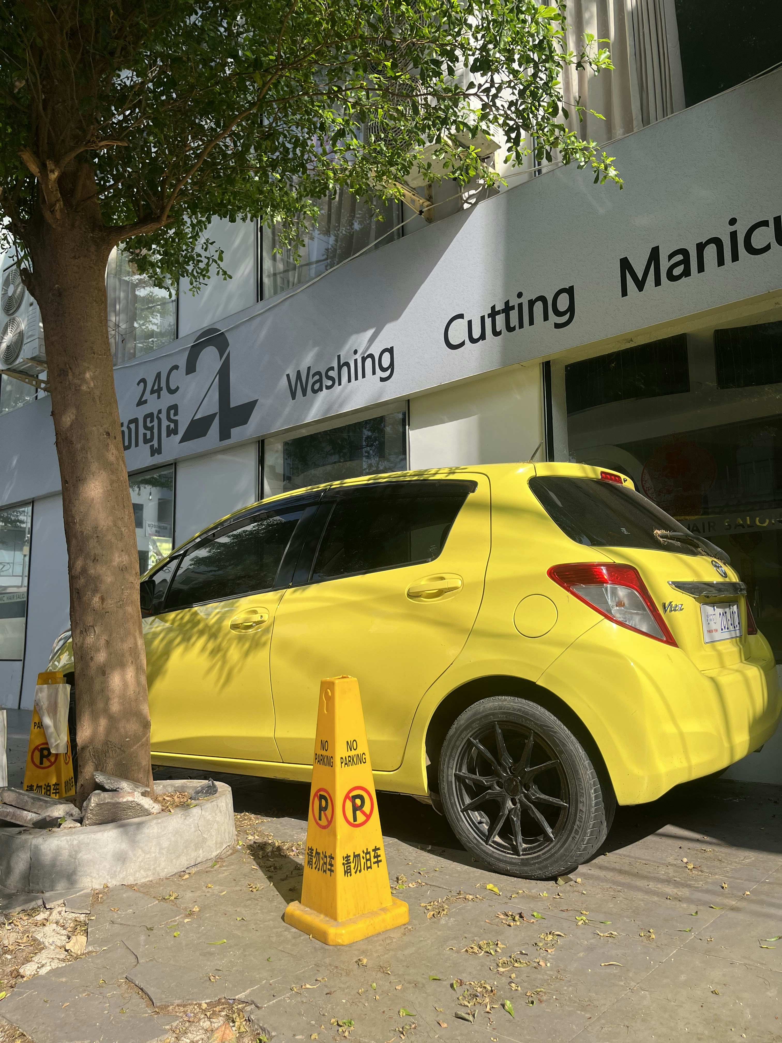 Yellow Taxi and Workshop Facade: Street Scene by the Curb