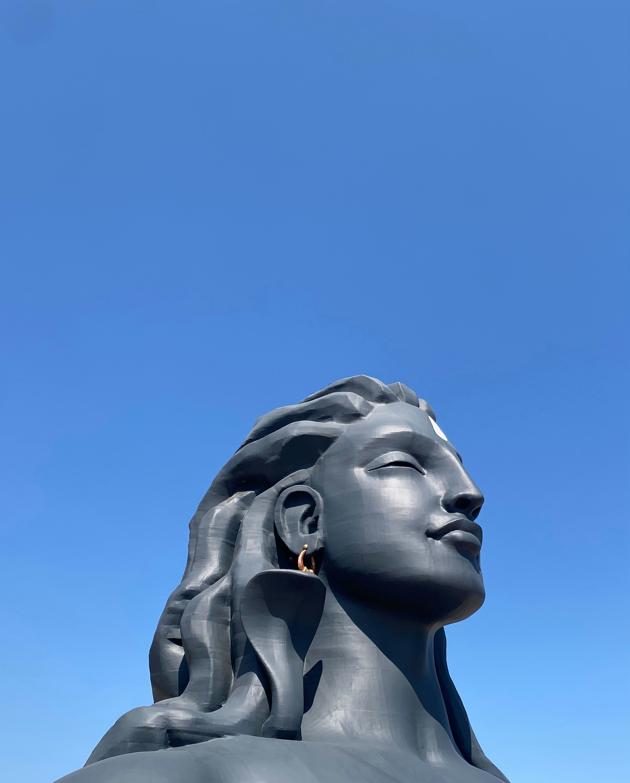 Bronze Serene Gaze Under a Blue Dome