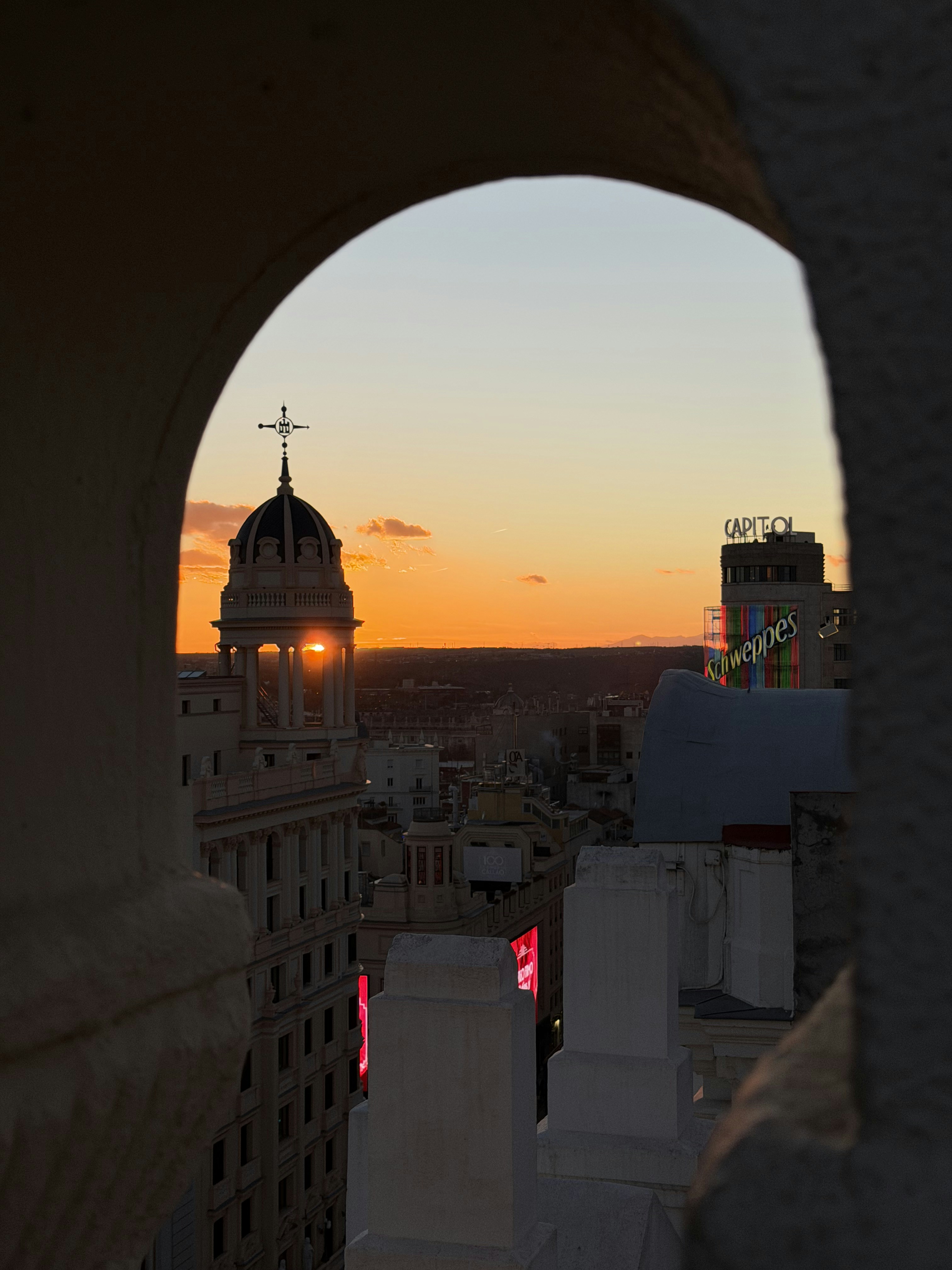 Sunset Through a City Arch: The Rooftop View