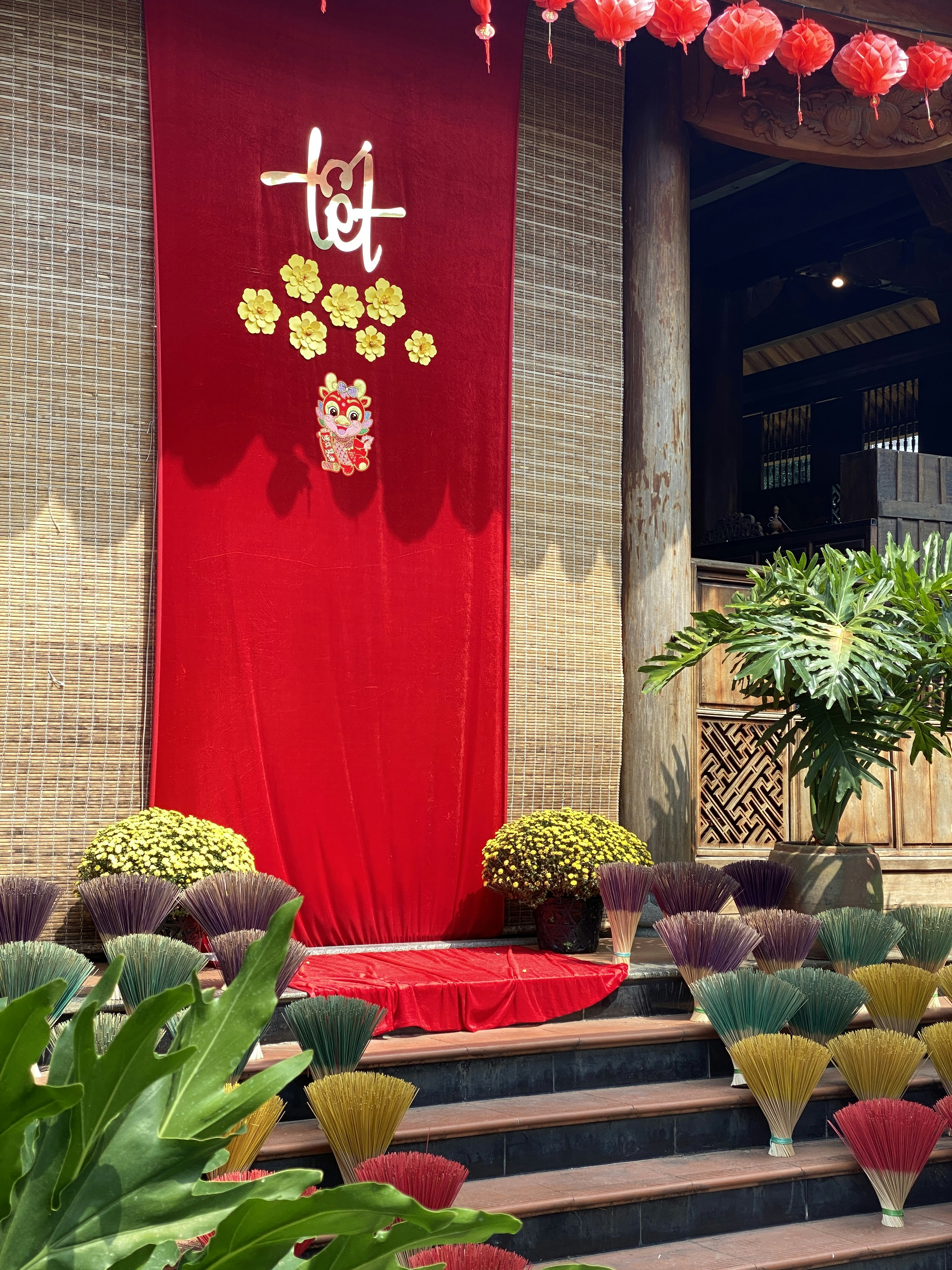 Red Drapes, Yellow Chrysanthemums, and Lanterns Guard a Festive Stair Step