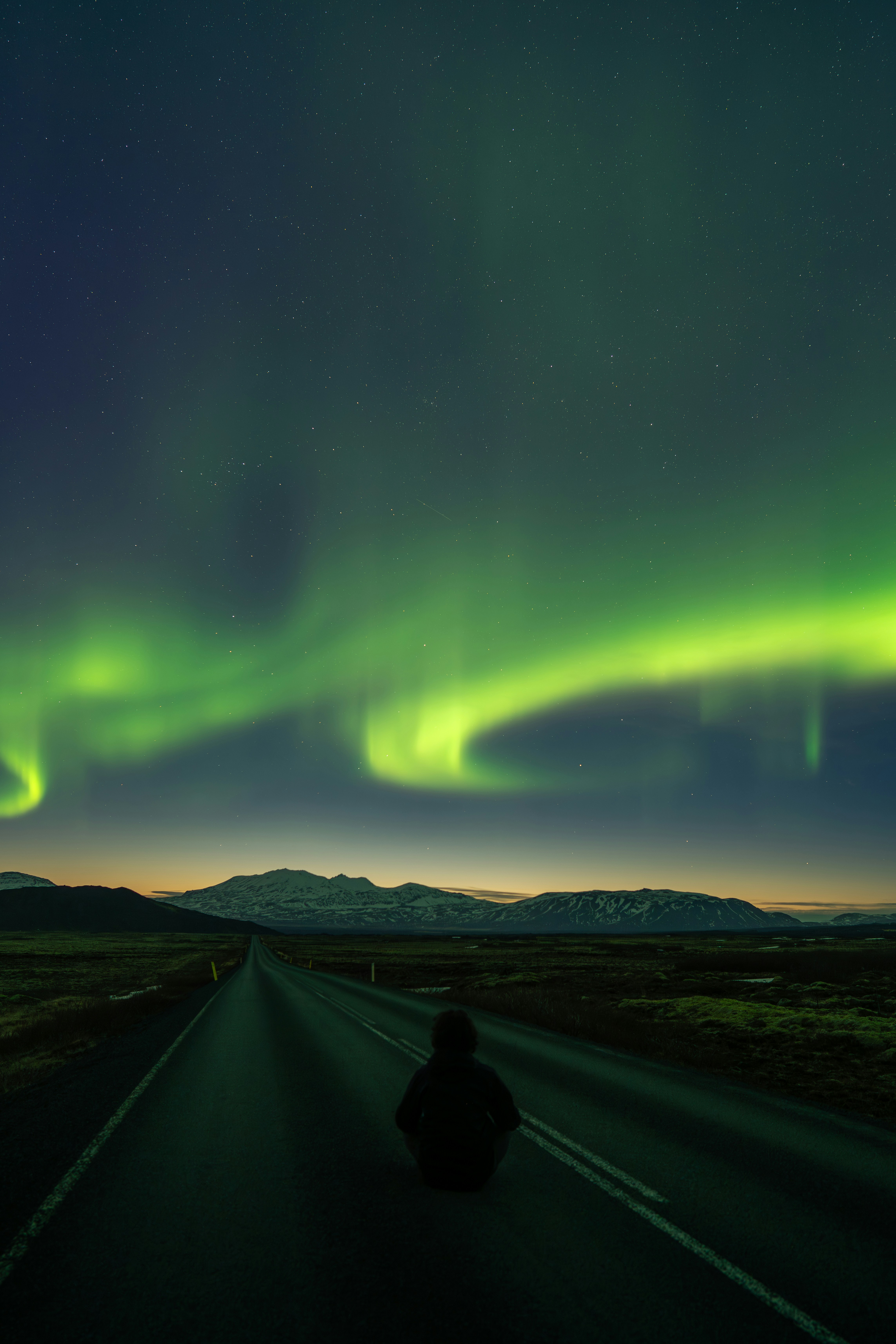 Road to the Aurora: A Lone Figure Beneath the Sky