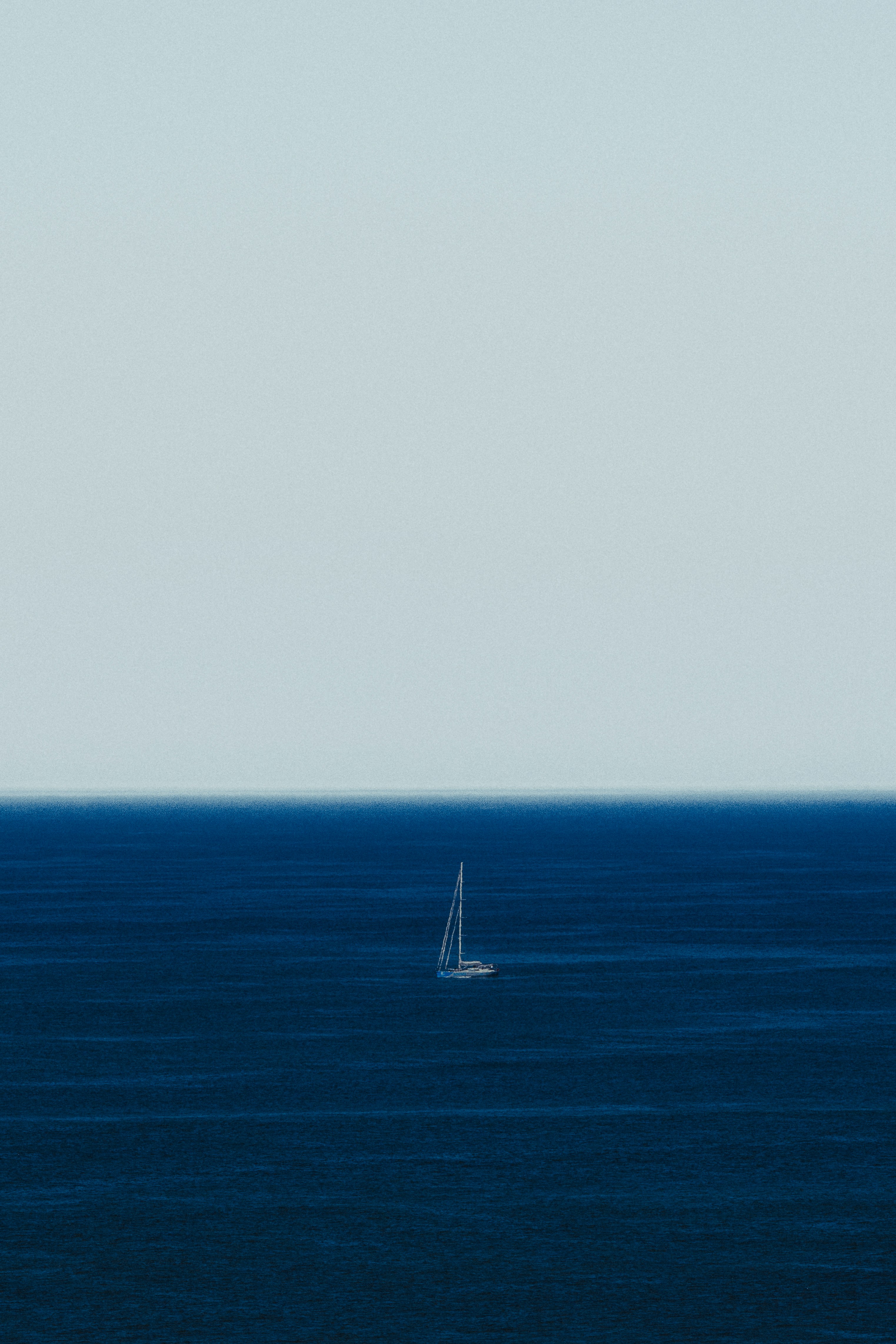 Solitary Sloop on a Horizon of Blue