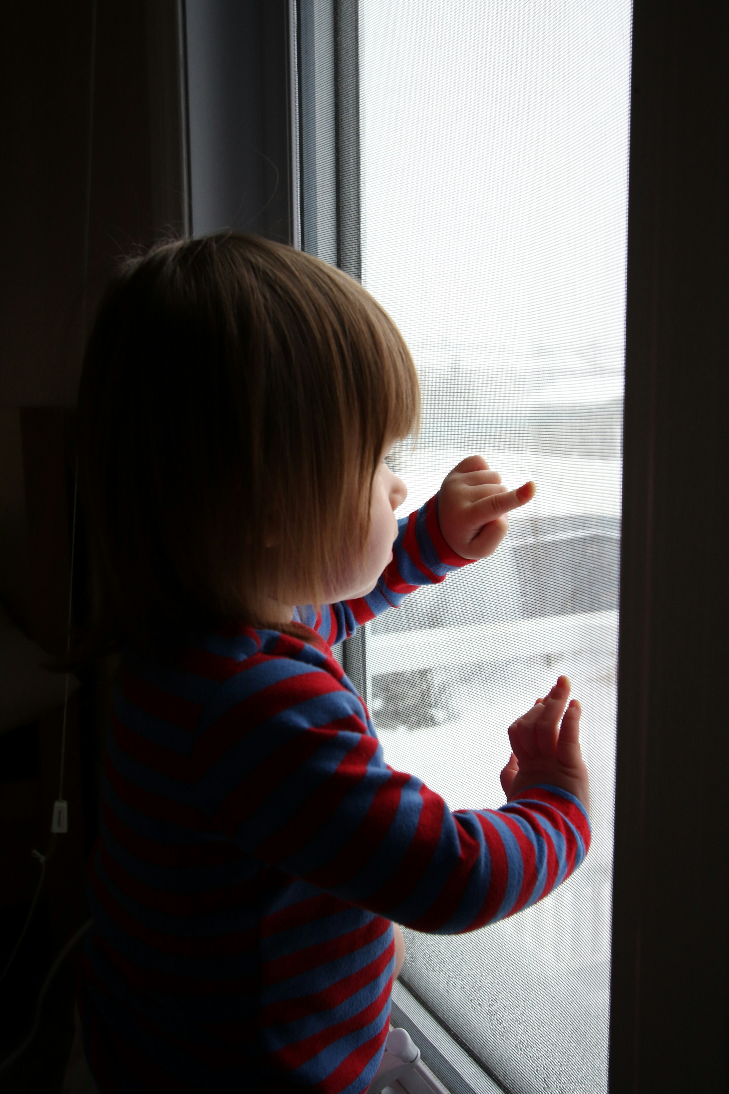 Window Wonder: A Child Reaches Toward the Frosted Glass