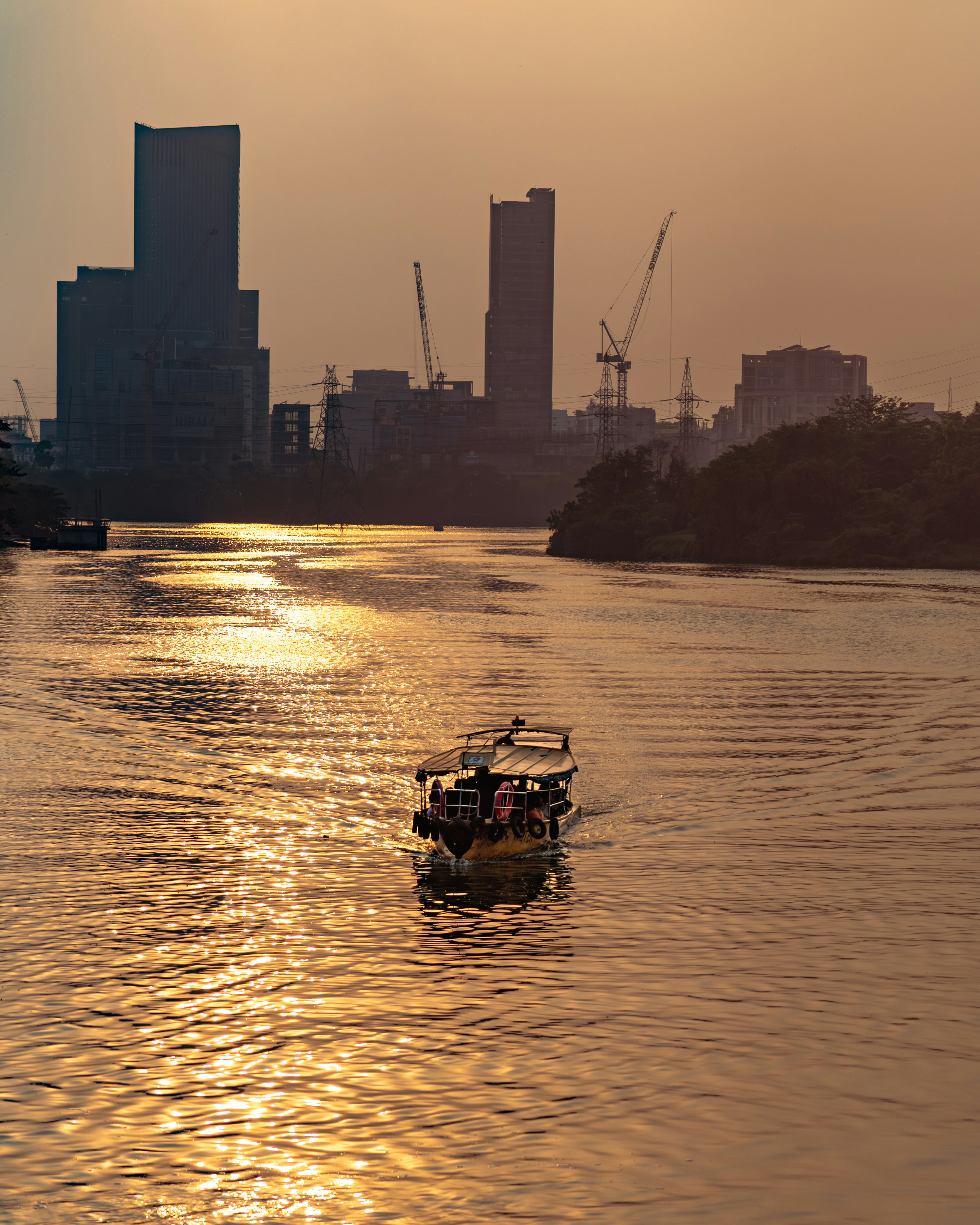 Golden Hour Passage: A Quiet River Awakens Under Skyscraper Silhouettes