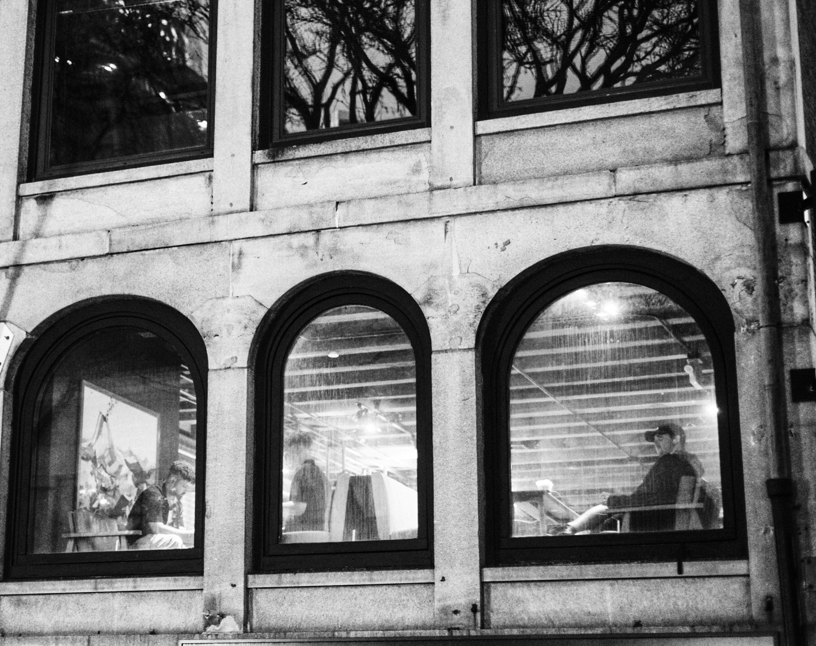 Arched Glasses in Shadowed Facades