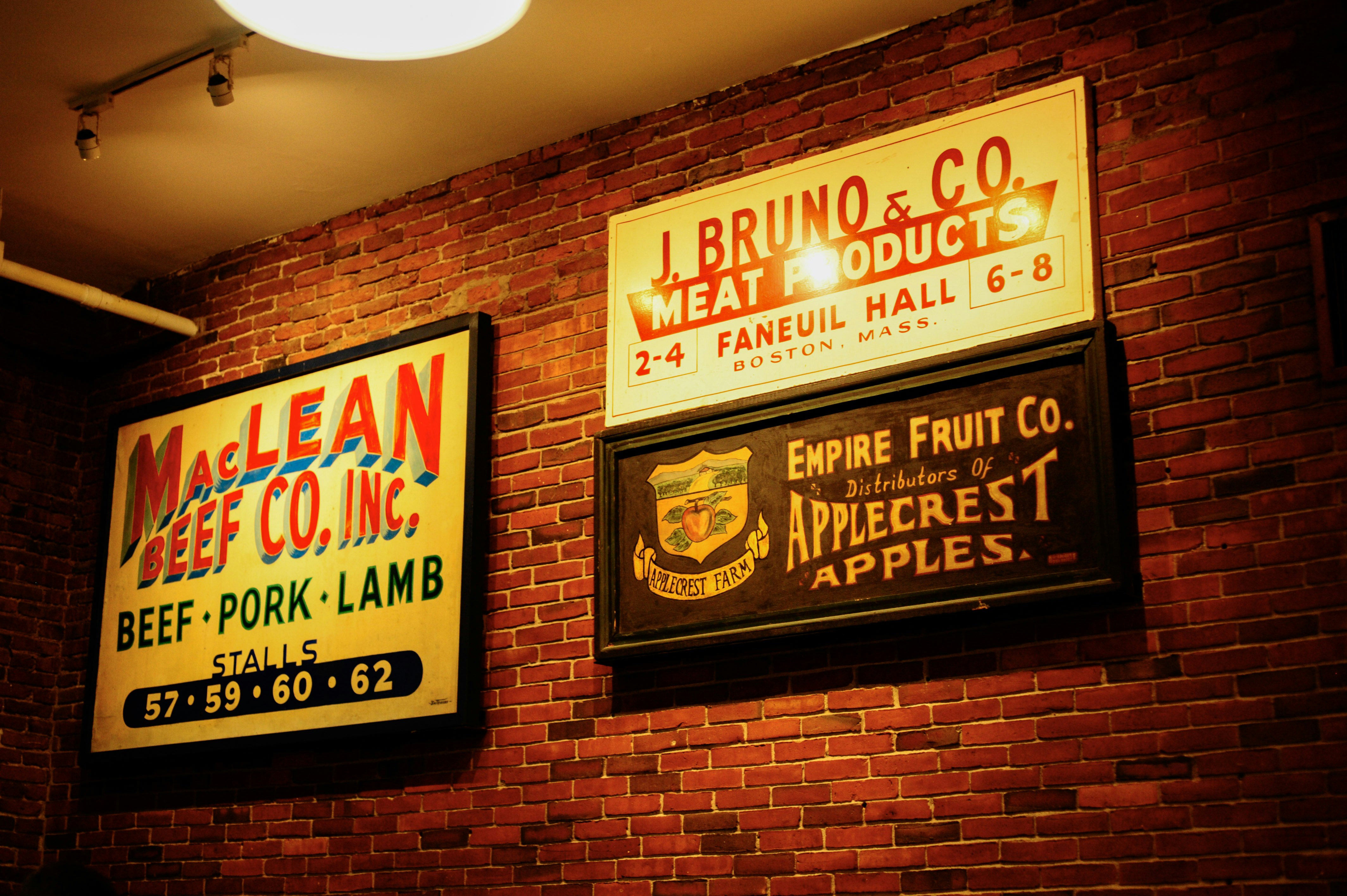 Brick Wall Gallery: Vintage Signage in Soft Ambient Light