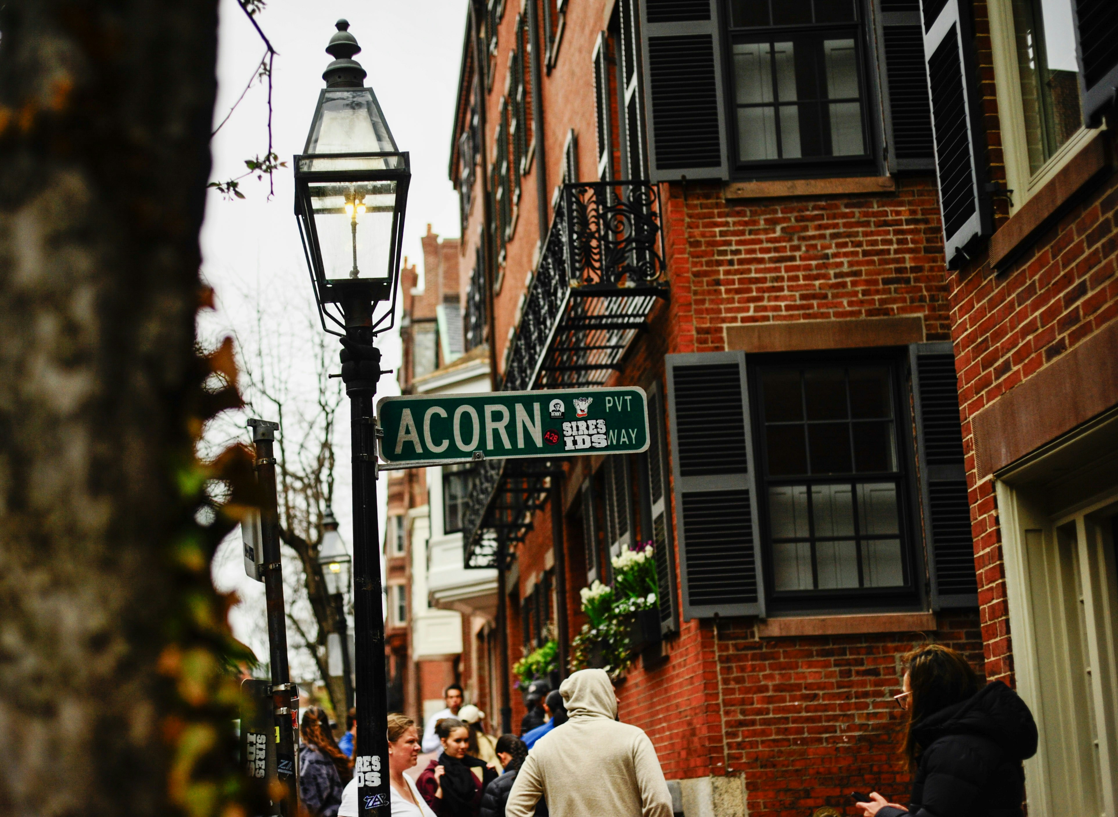 Acorn Street Corner: Warm Reds and a Clocked Moment Under a Lantern