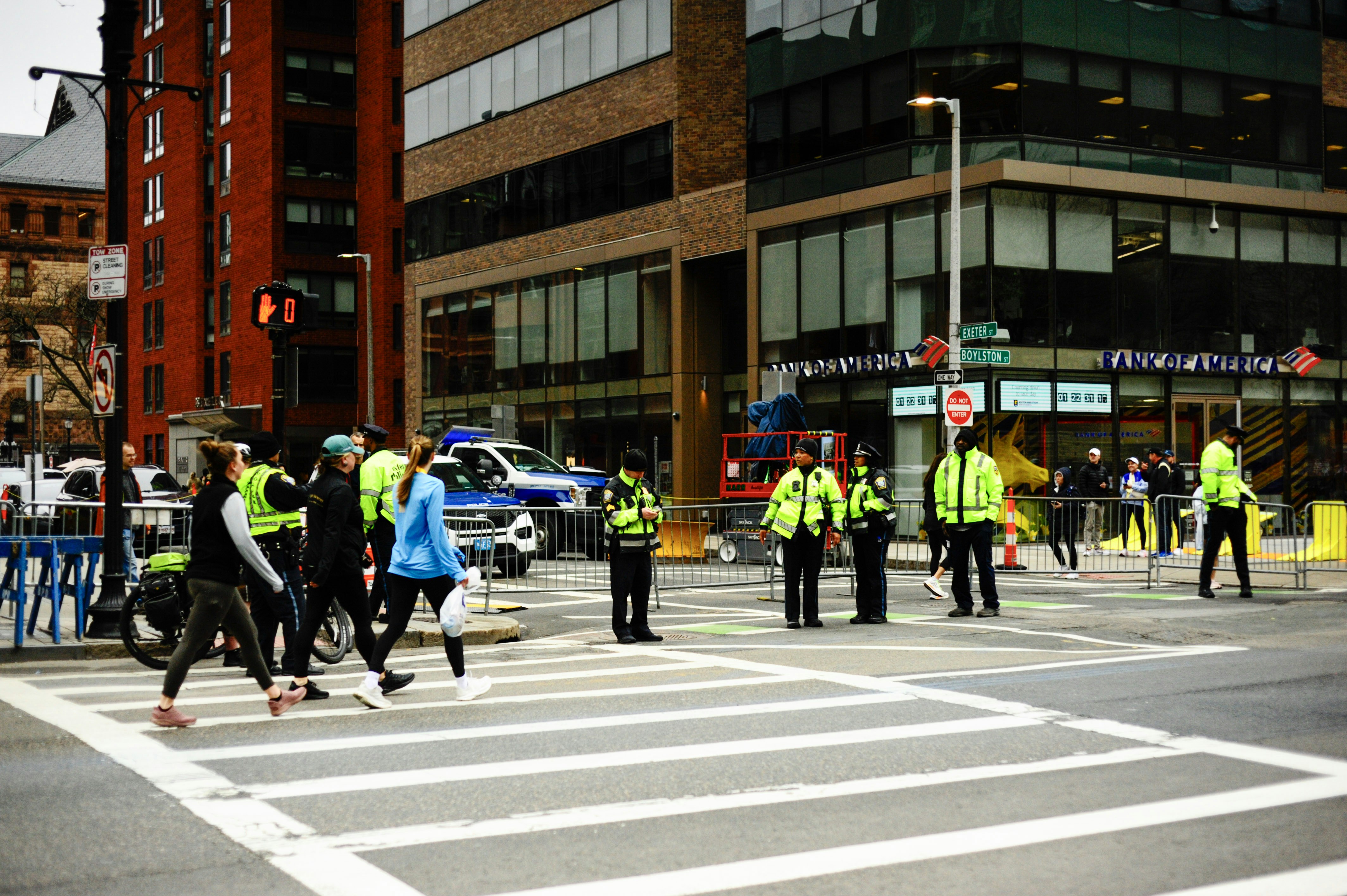 Crossing Guarded Street: Neon Vests and City Blockade