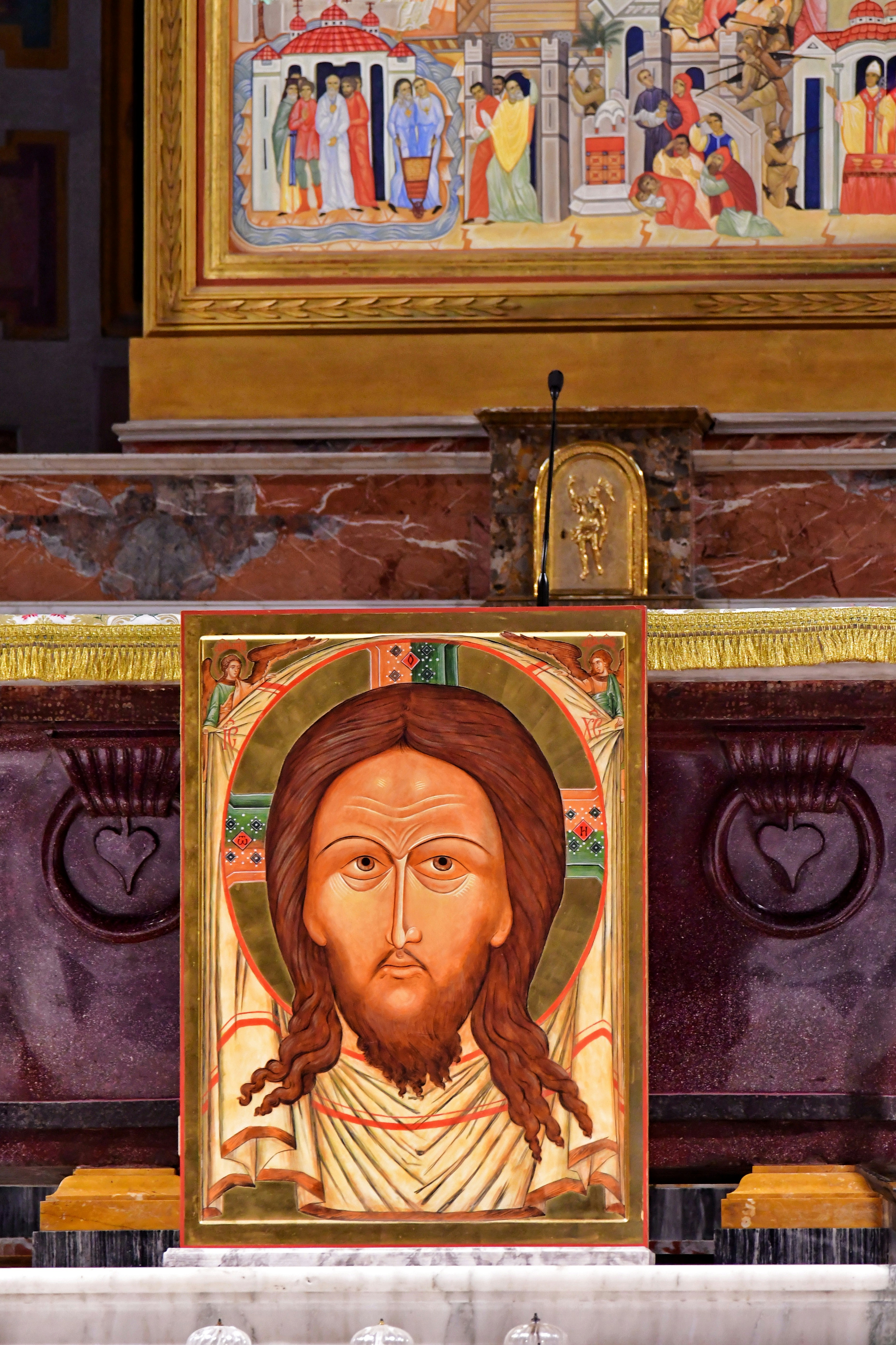 Icon of Serenity: The Sacred Portrait Framed by Marble and Gold