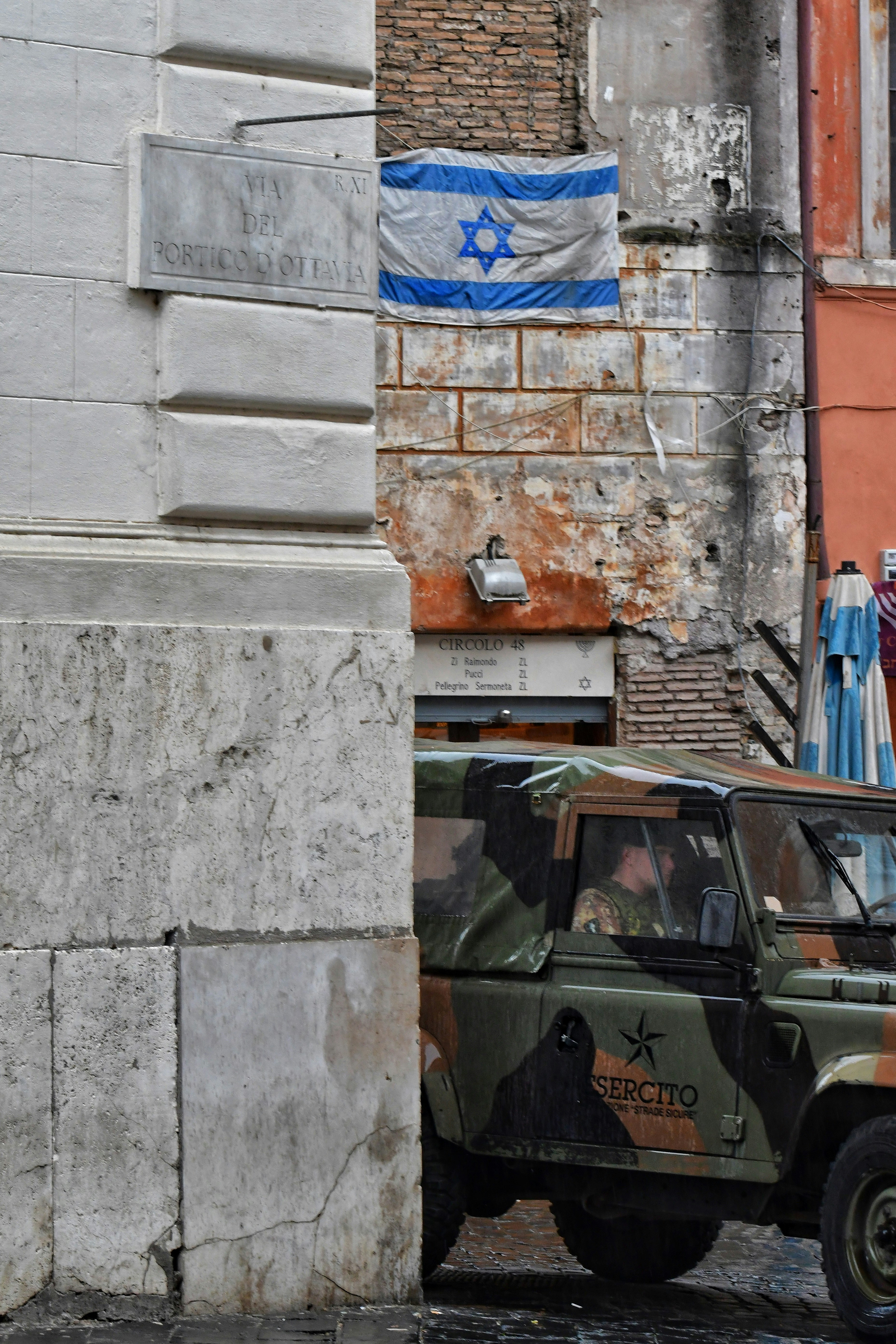 Flag Over Brick and Vehicle in an Urban Corner