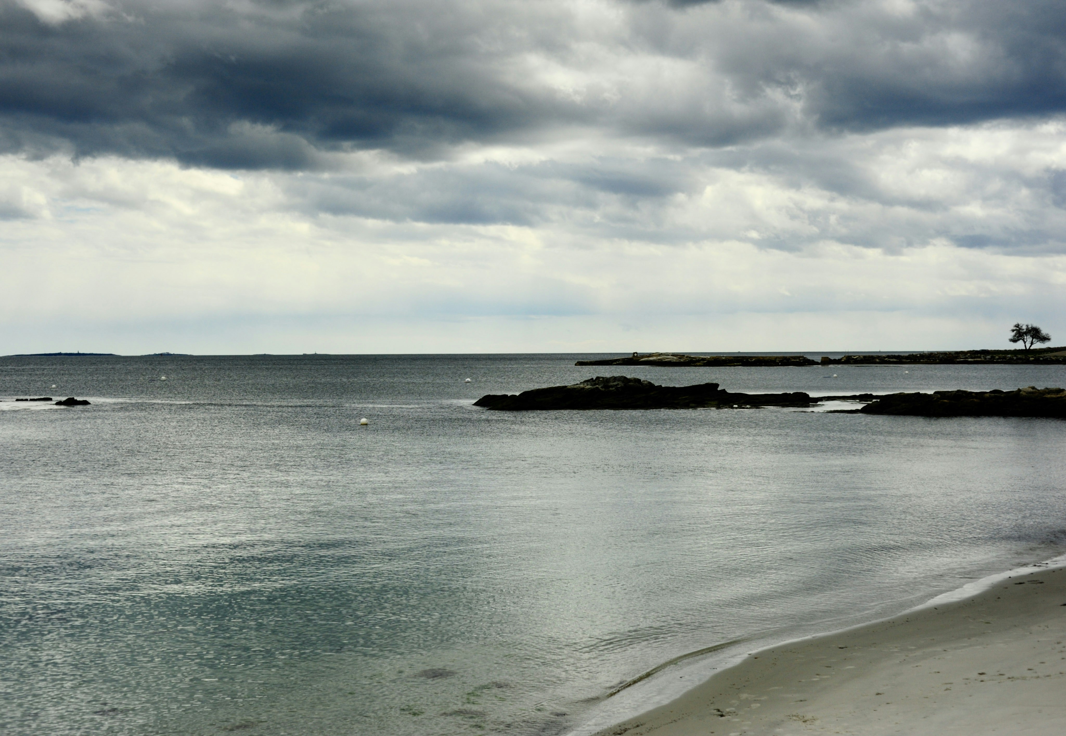 Quiet Horizon: Sunlight Breaks Over a Serene Seascape