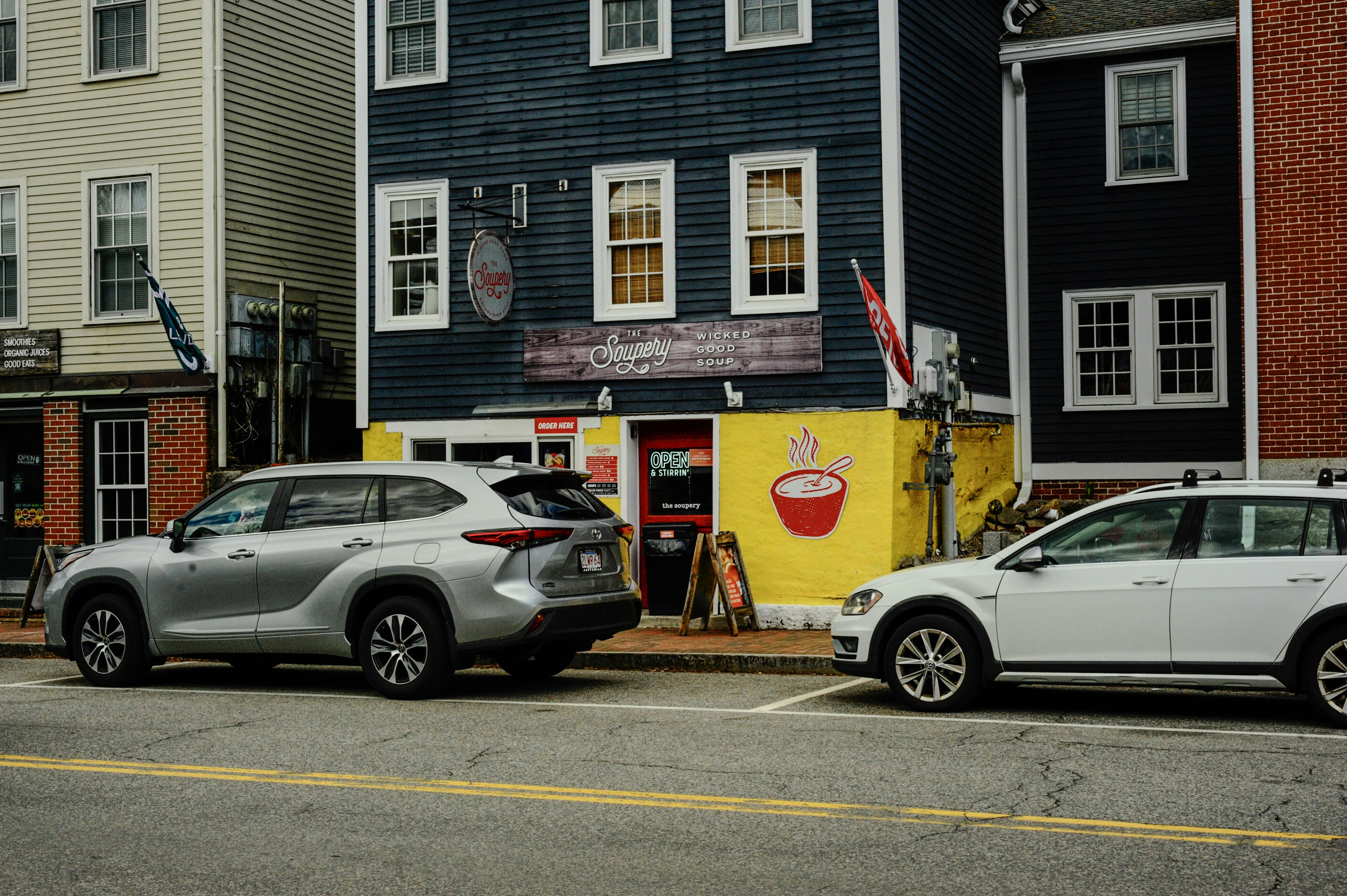 Colorful Row of Townhouse Facades Behind a Parked Car Oasis