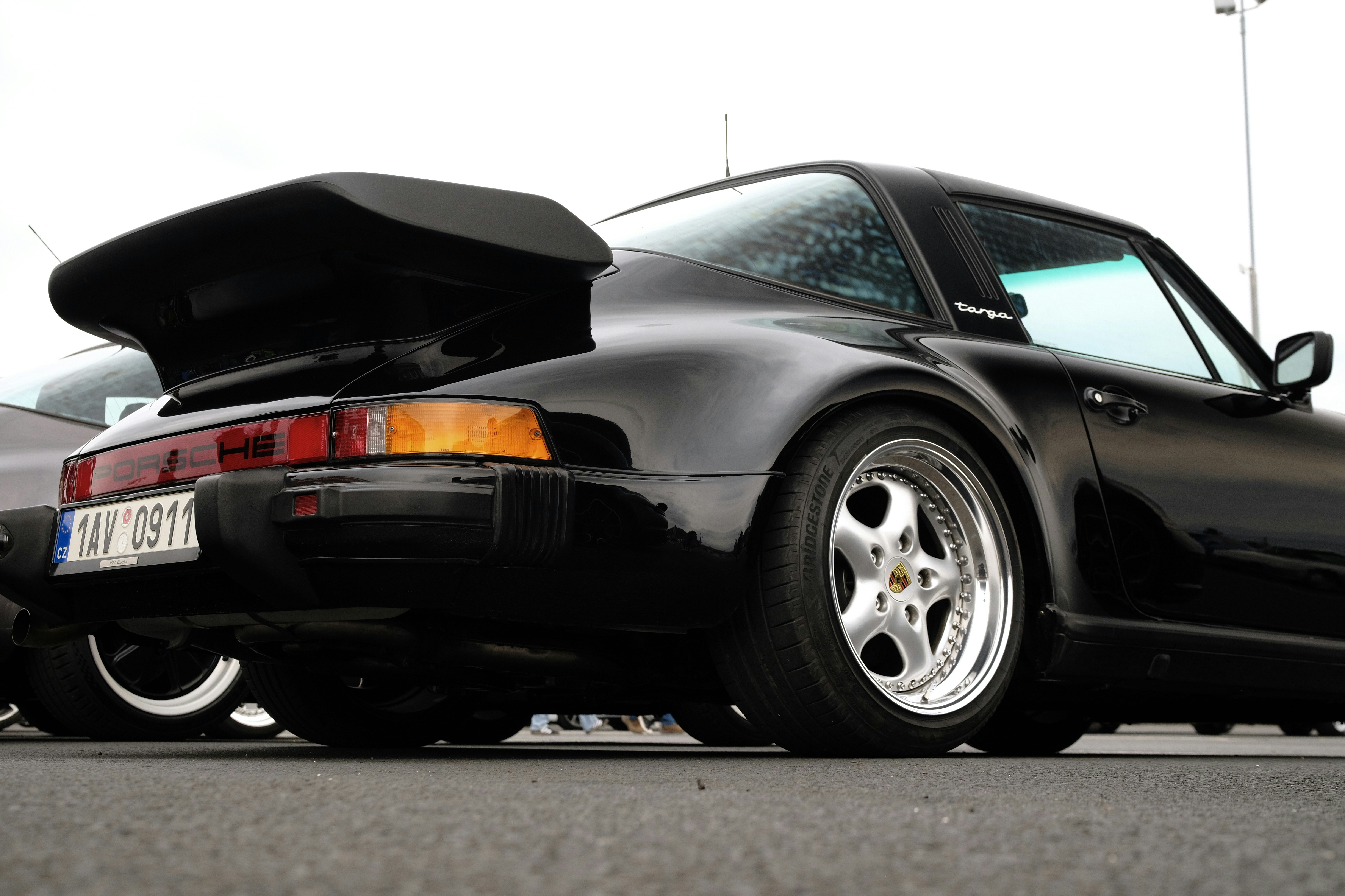 Low-Slung Shadow: A Classic Porsche Stands at the Backlot Edge