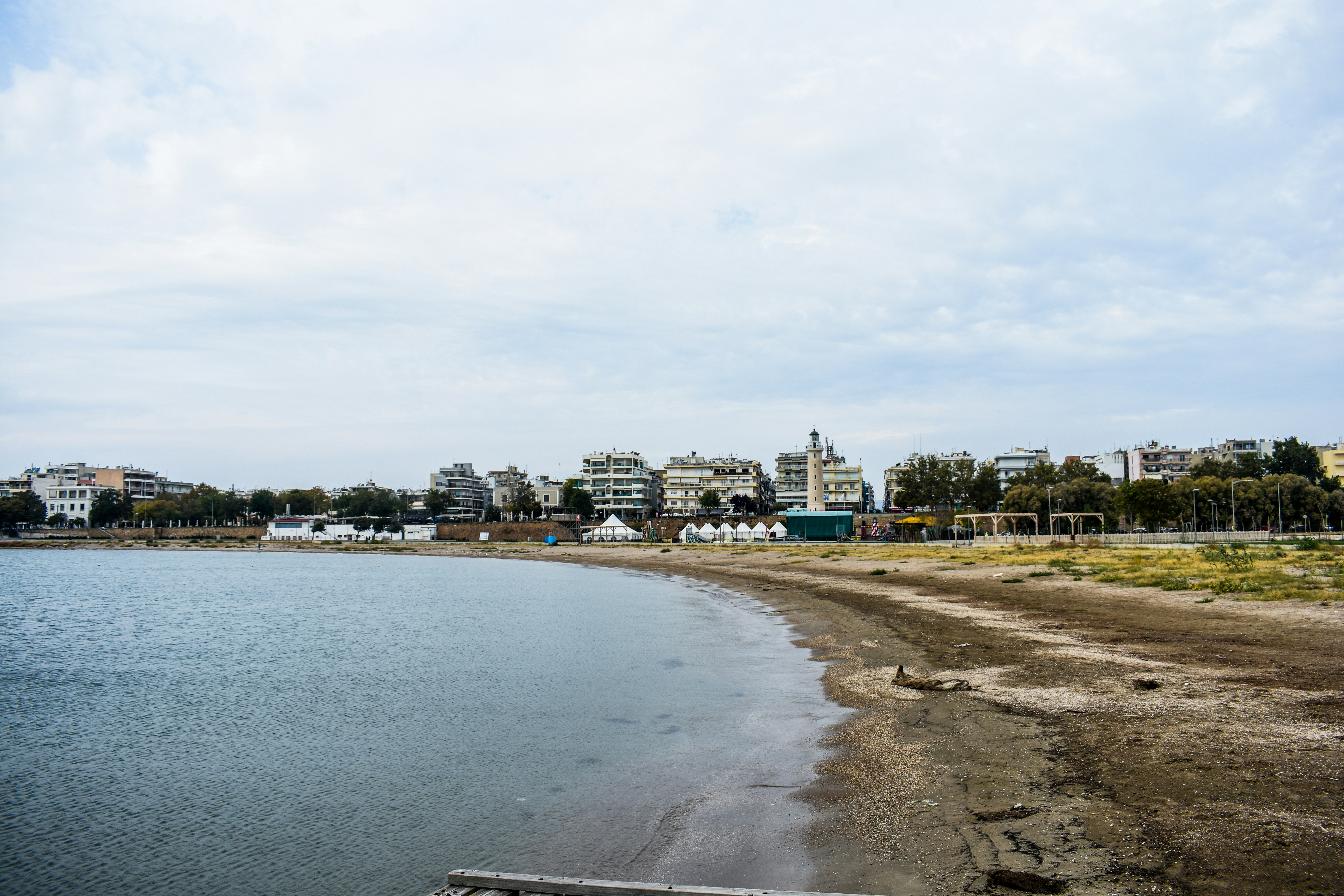 Coastal Boulevard: Quiet shoreline with distant apartment row