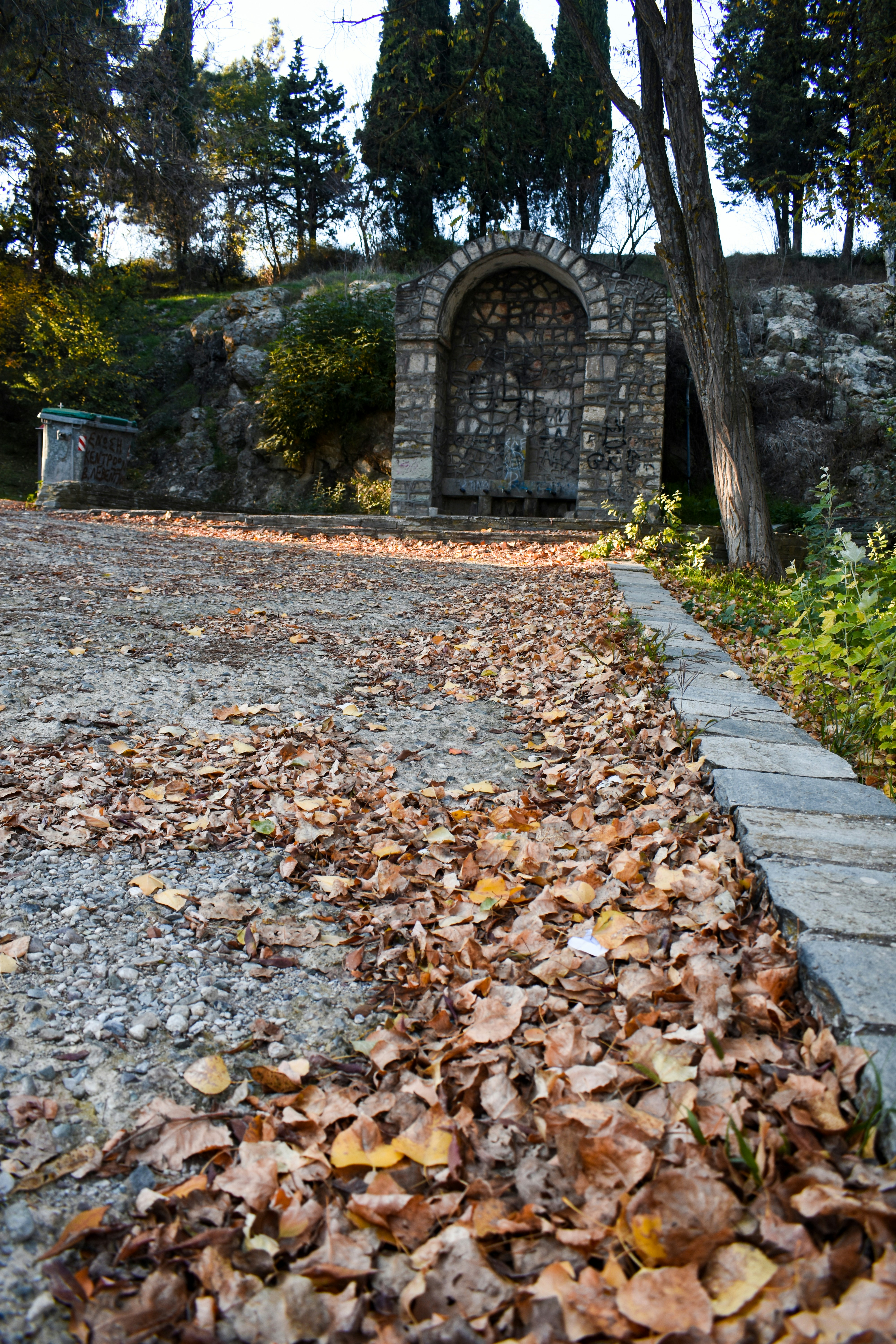 Stone Shrine Framed by Autumn Leaves