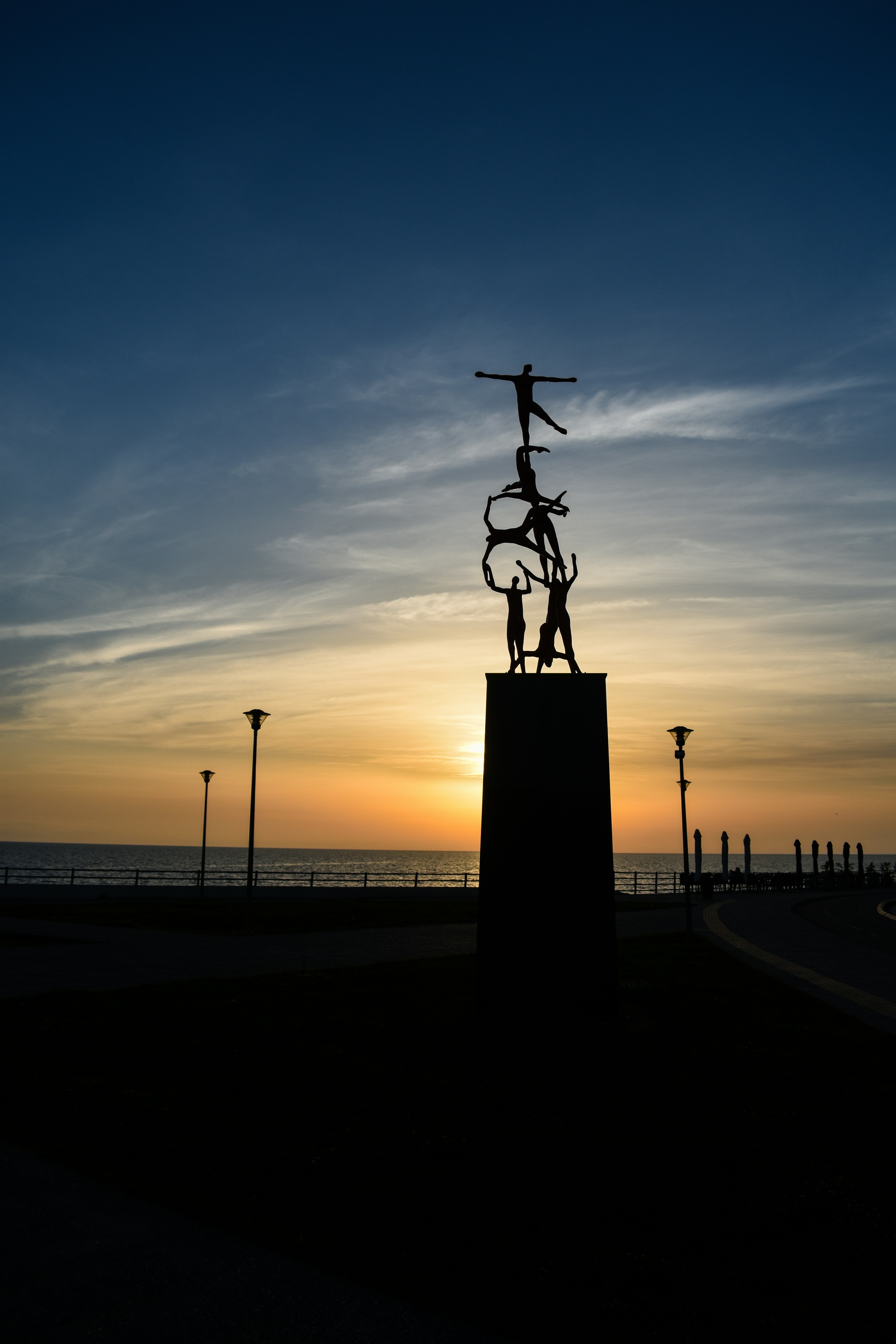 Sunset Silhouette: A Balancing Act at the Pier