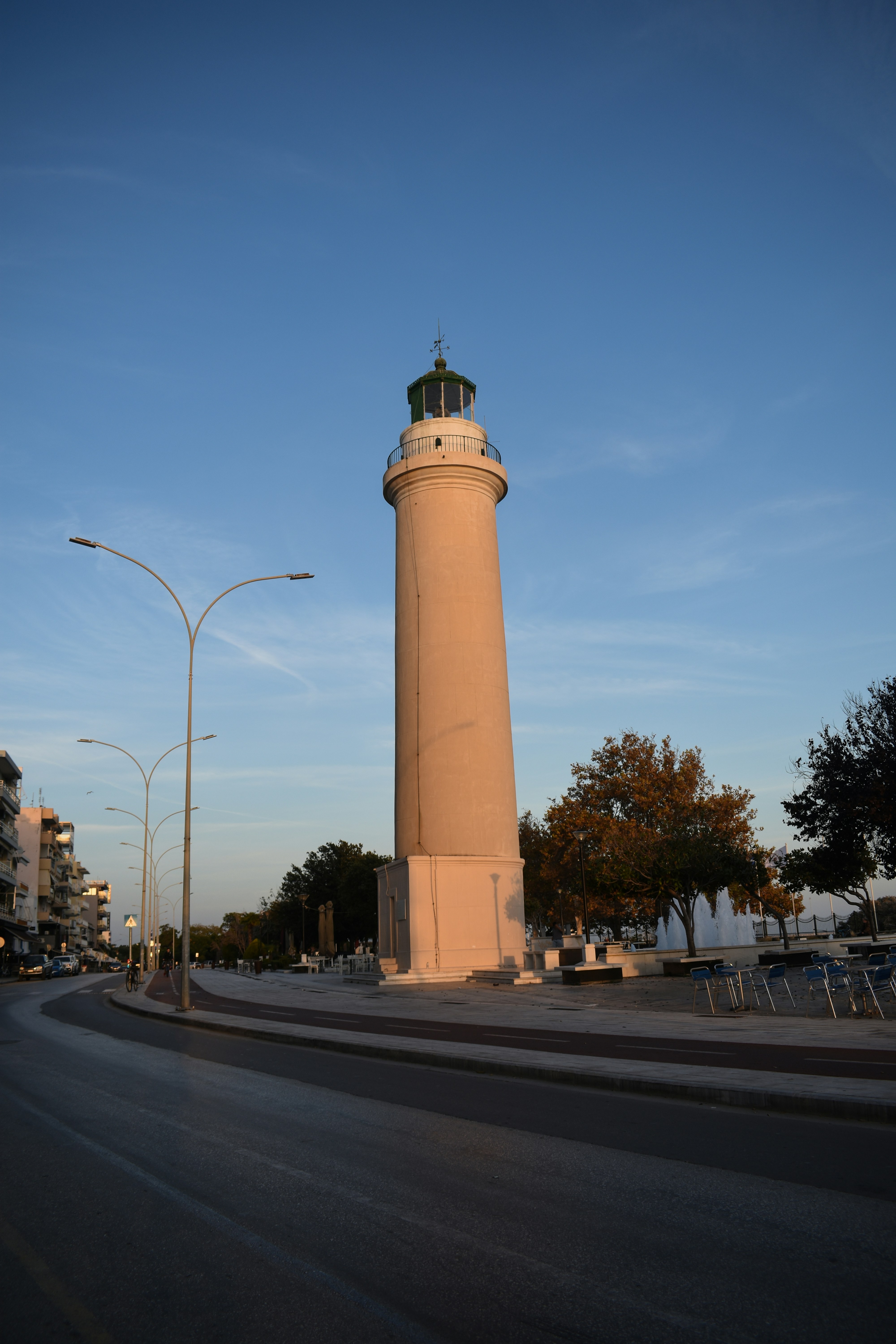 Lighthouse at Dusk: A Sea-Swept Promenade Standing Guard