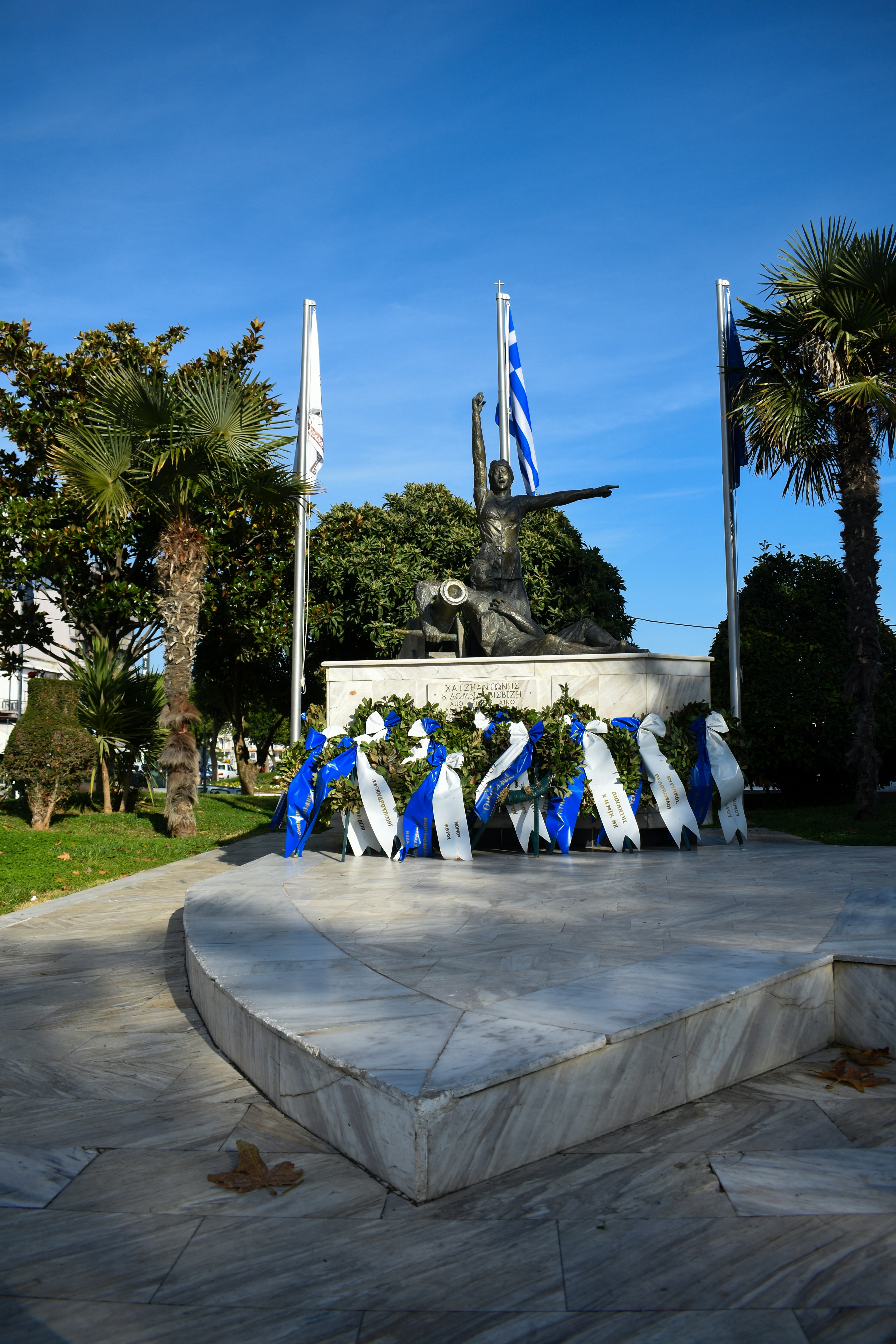 Flag-Bedecked Monument Reaching Toward a Clear Blue Sky