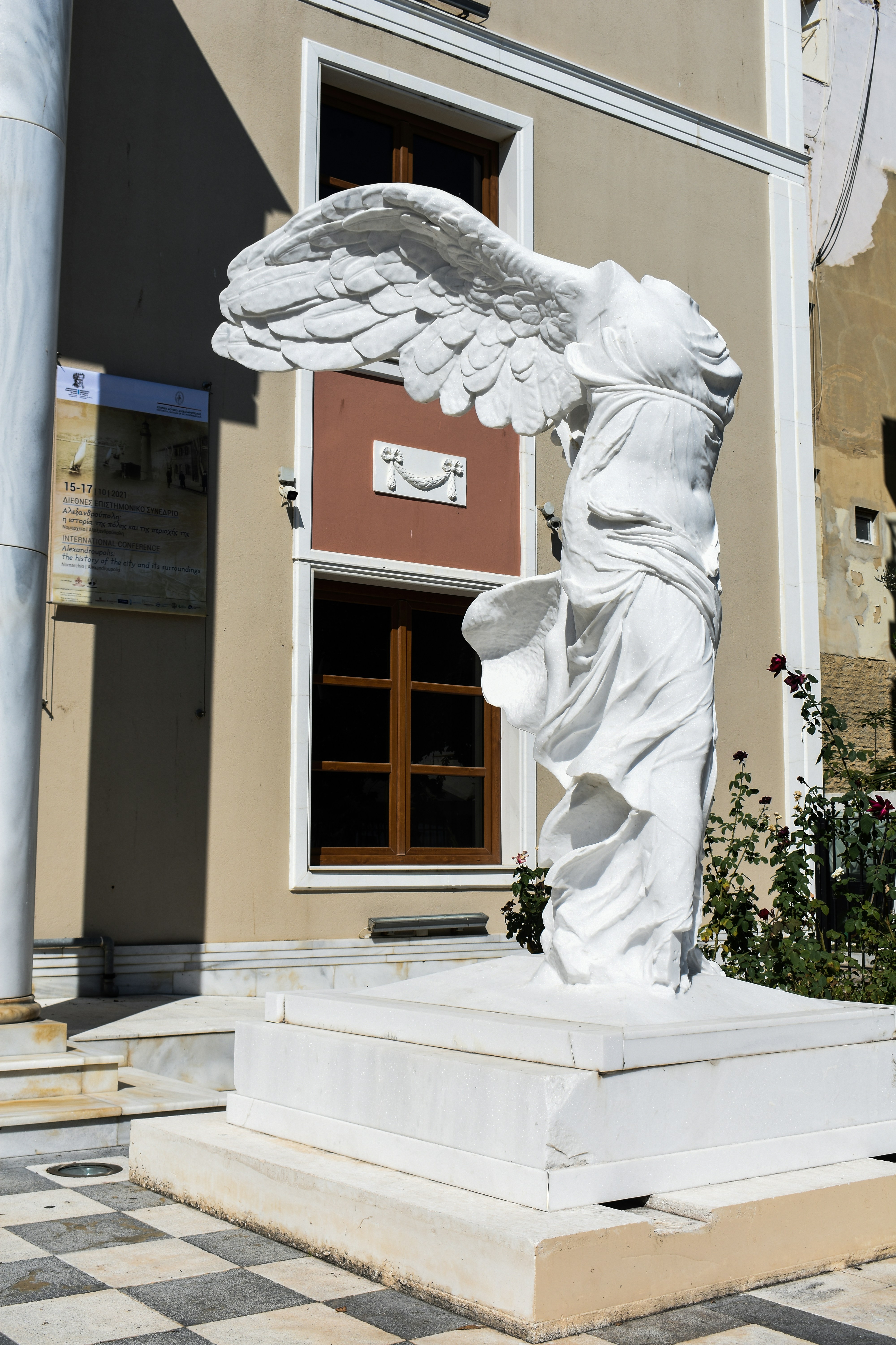 Winged Guardian in Front of a Sunlit Facade