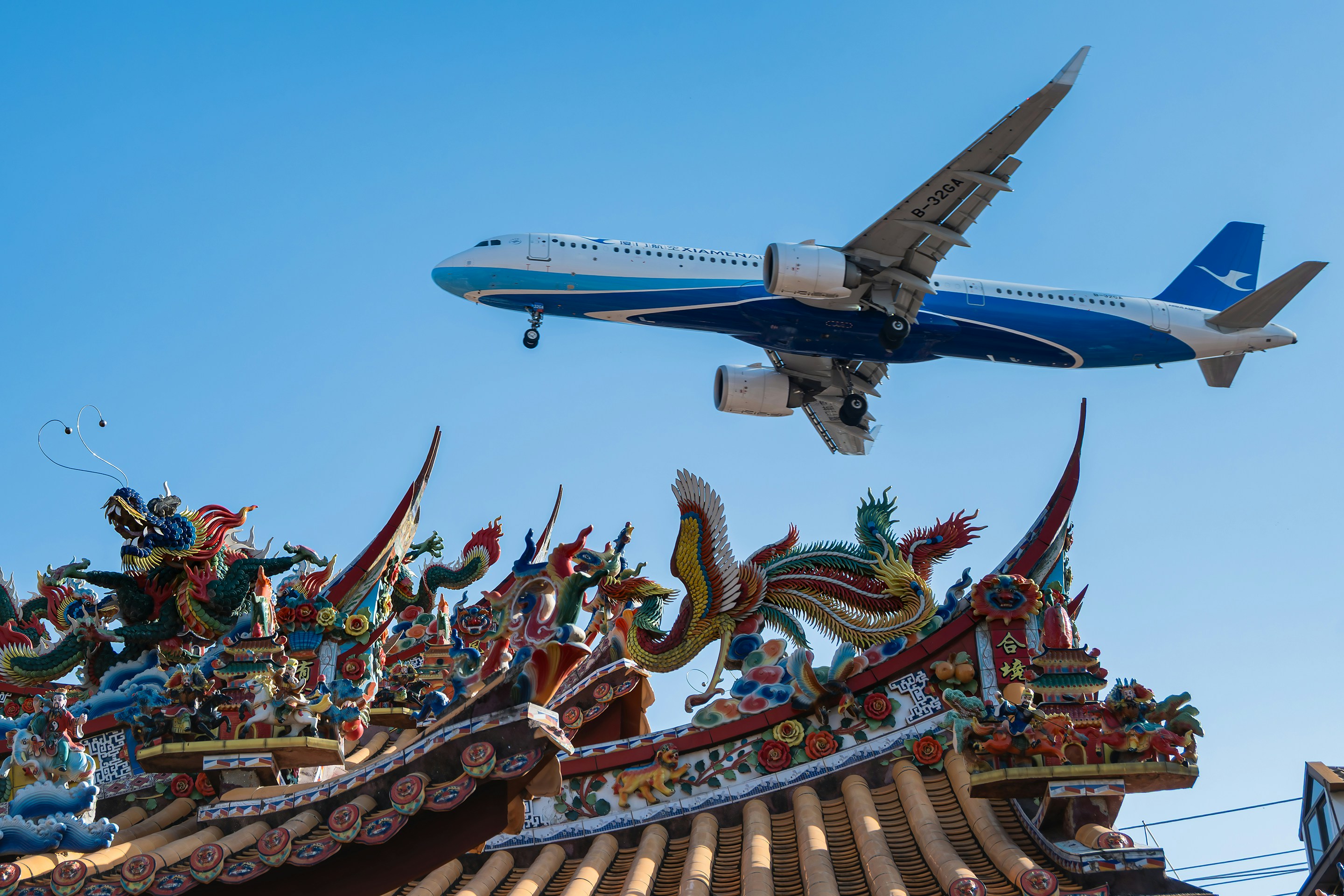 Airliner Over Temple Corridors: A Bright Passage in Blue
