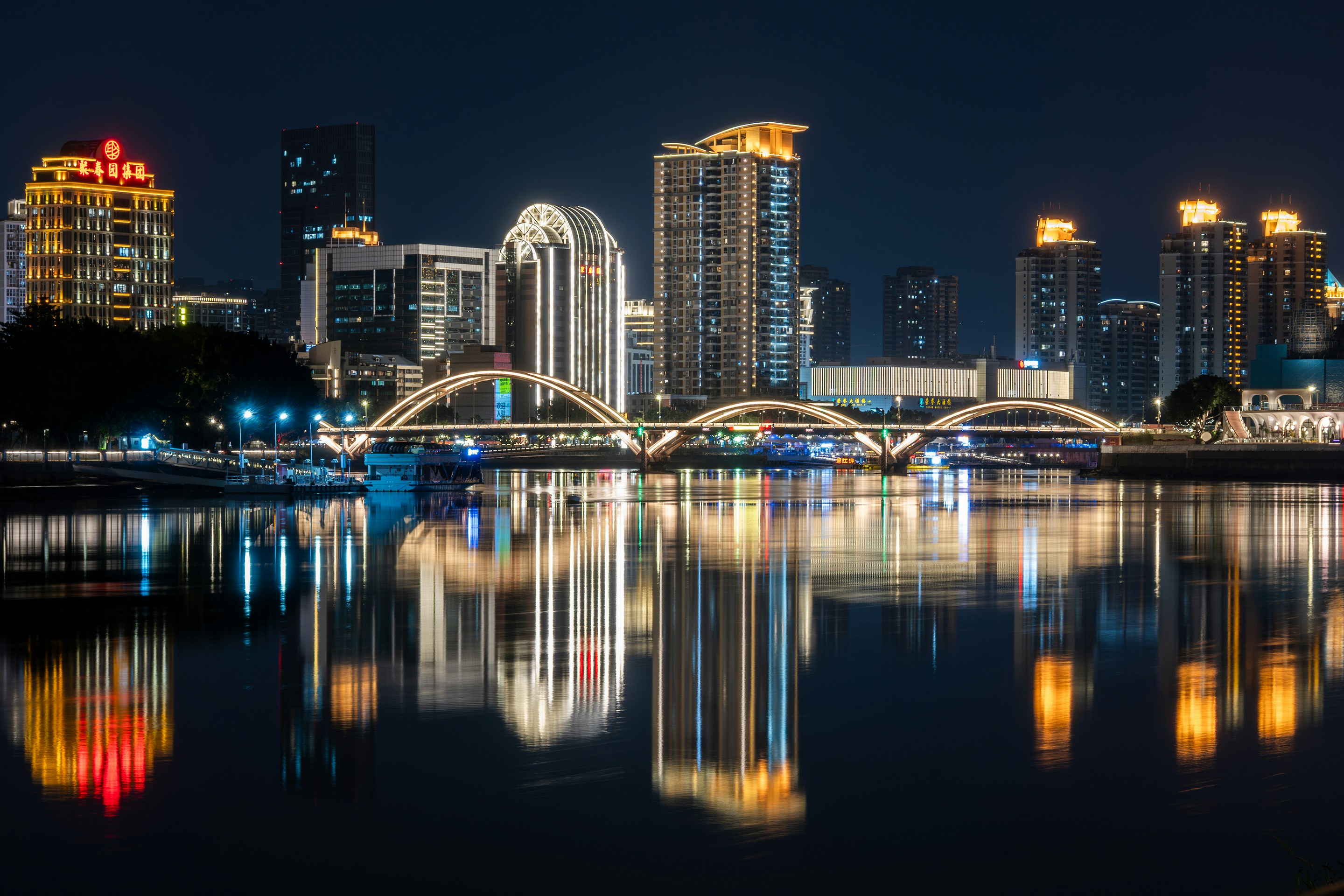 City Reflections: Neon Arches Over a Night River