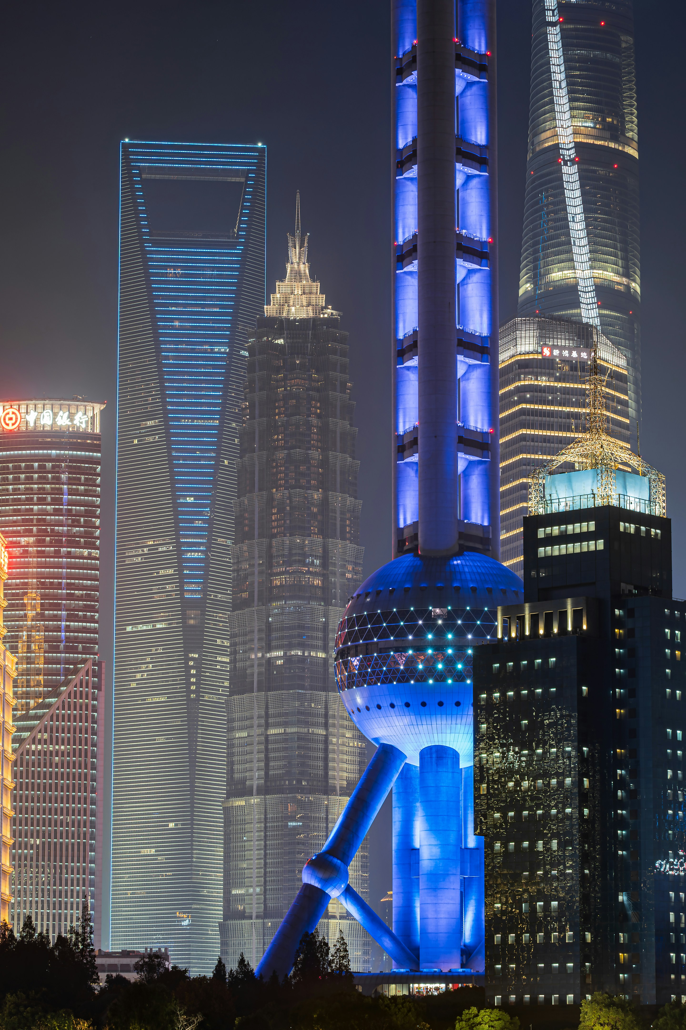 Neon Axis: The Shanghai Night Skyline with the Bundled Orb in Blue