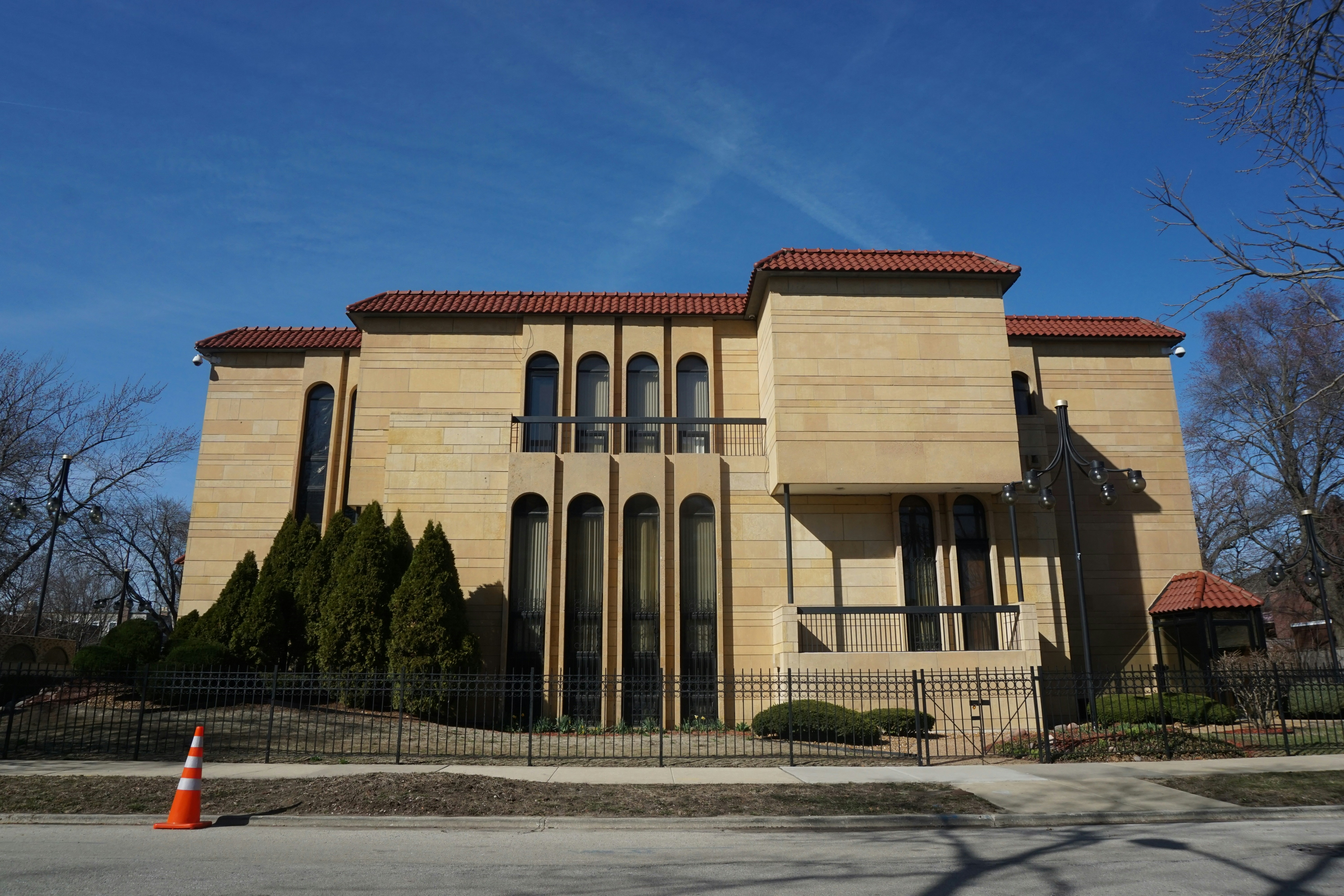 Temple-like sandstone facade rises beneath a clear blue sky
