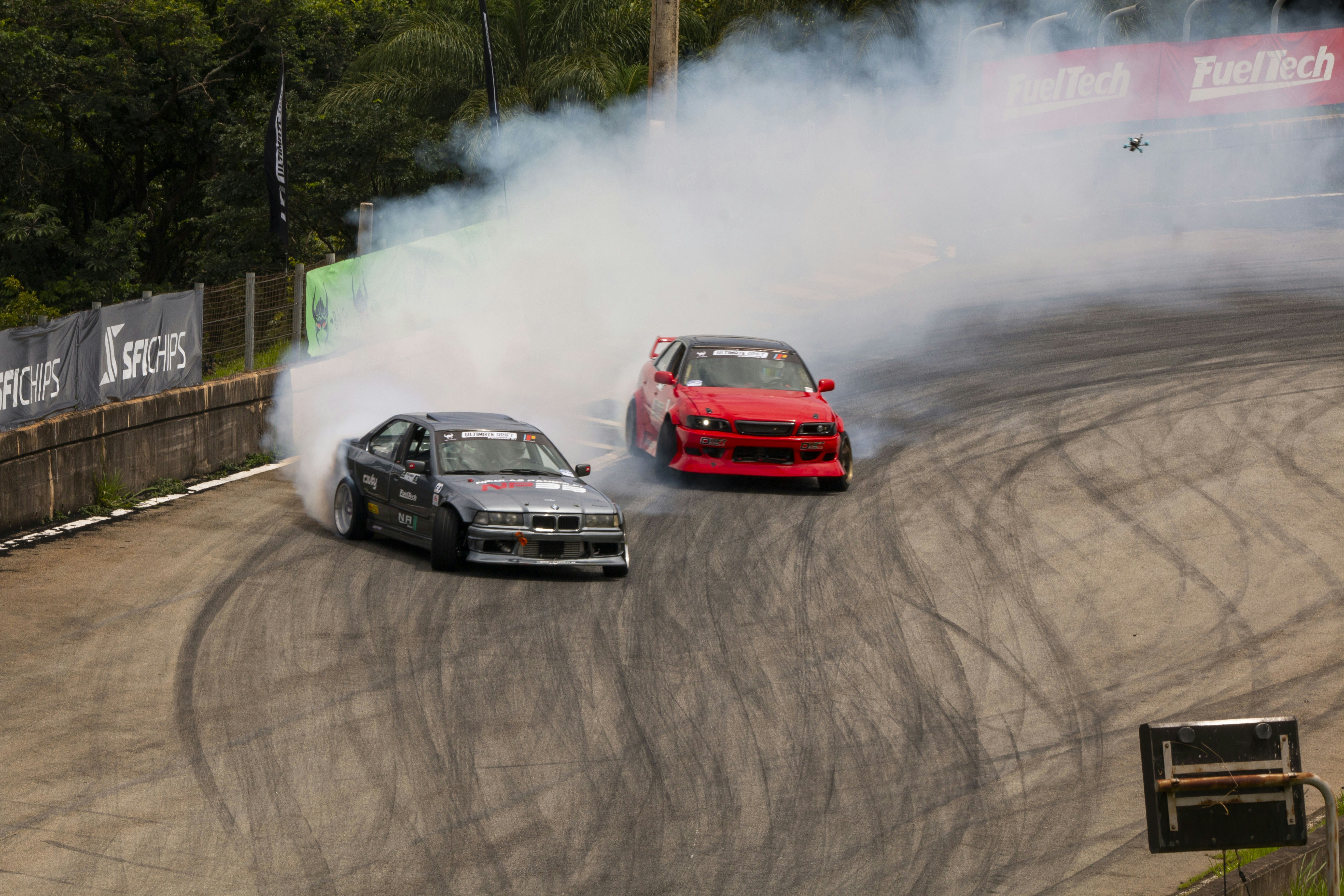 Drift Duel: A Pair of Fighters Converge in a Smoke-Soaked Corner