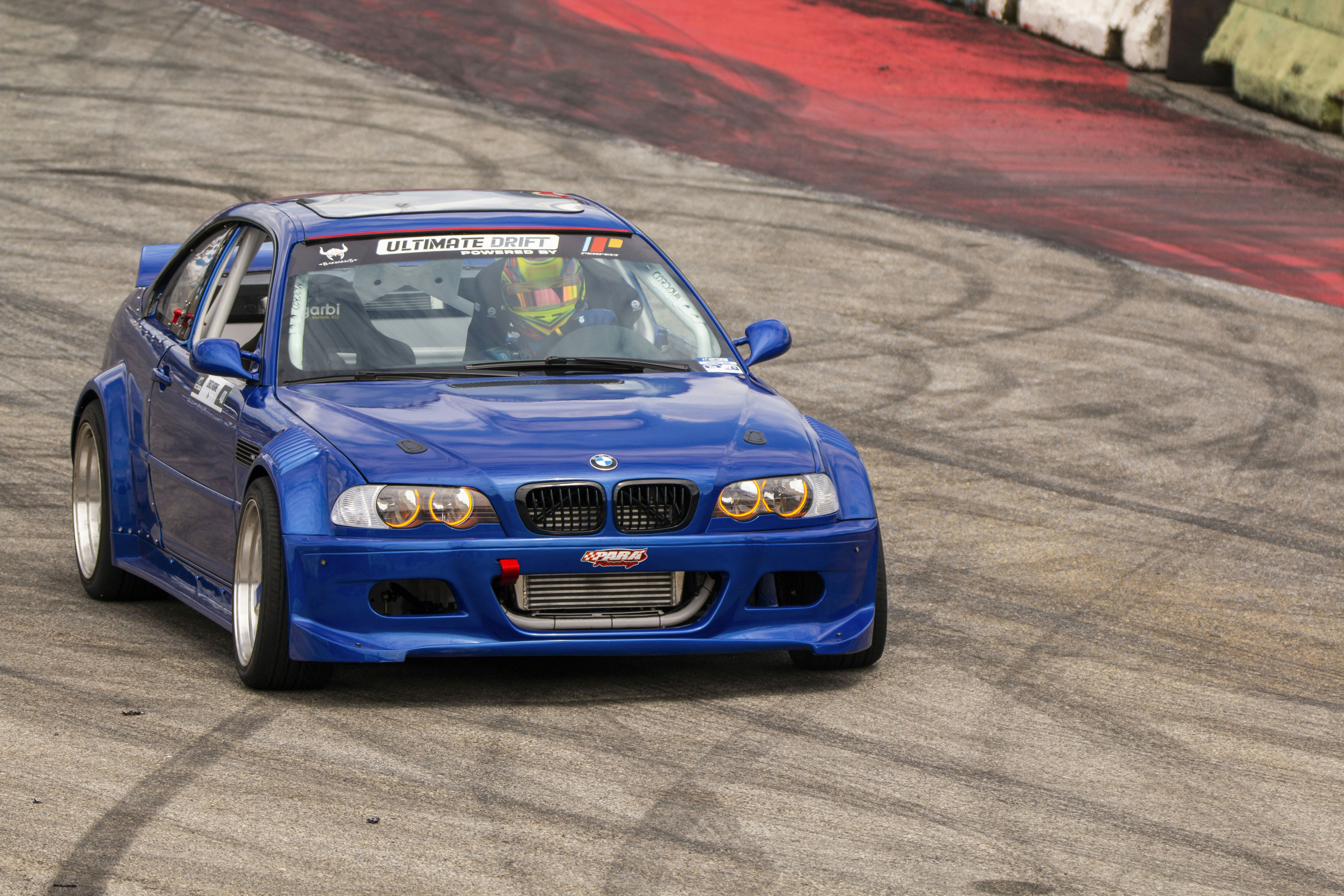 Blue race car bites into the tarmac bend