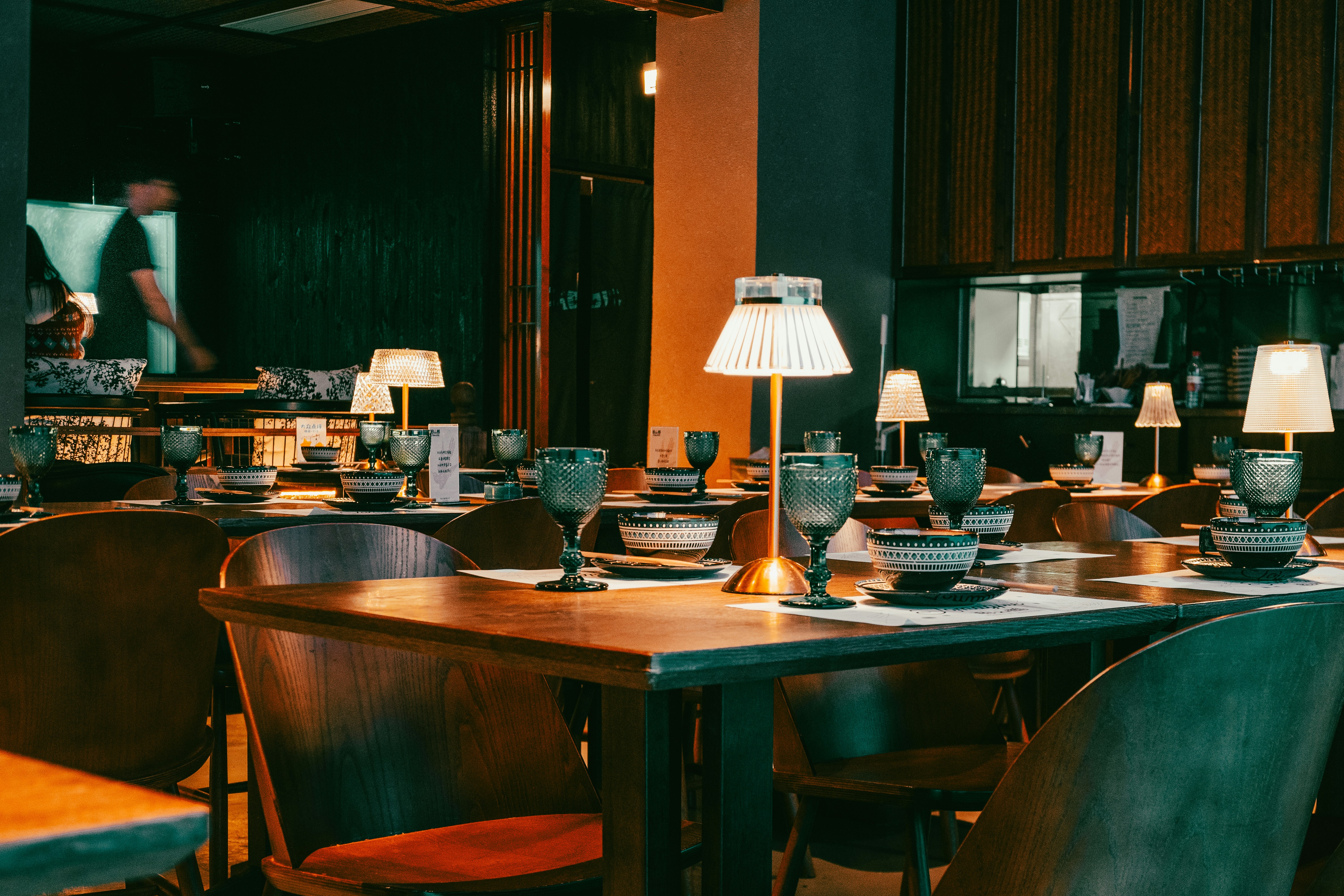 Muted Warmth: A Quiet Dinner Scene Under Lamps