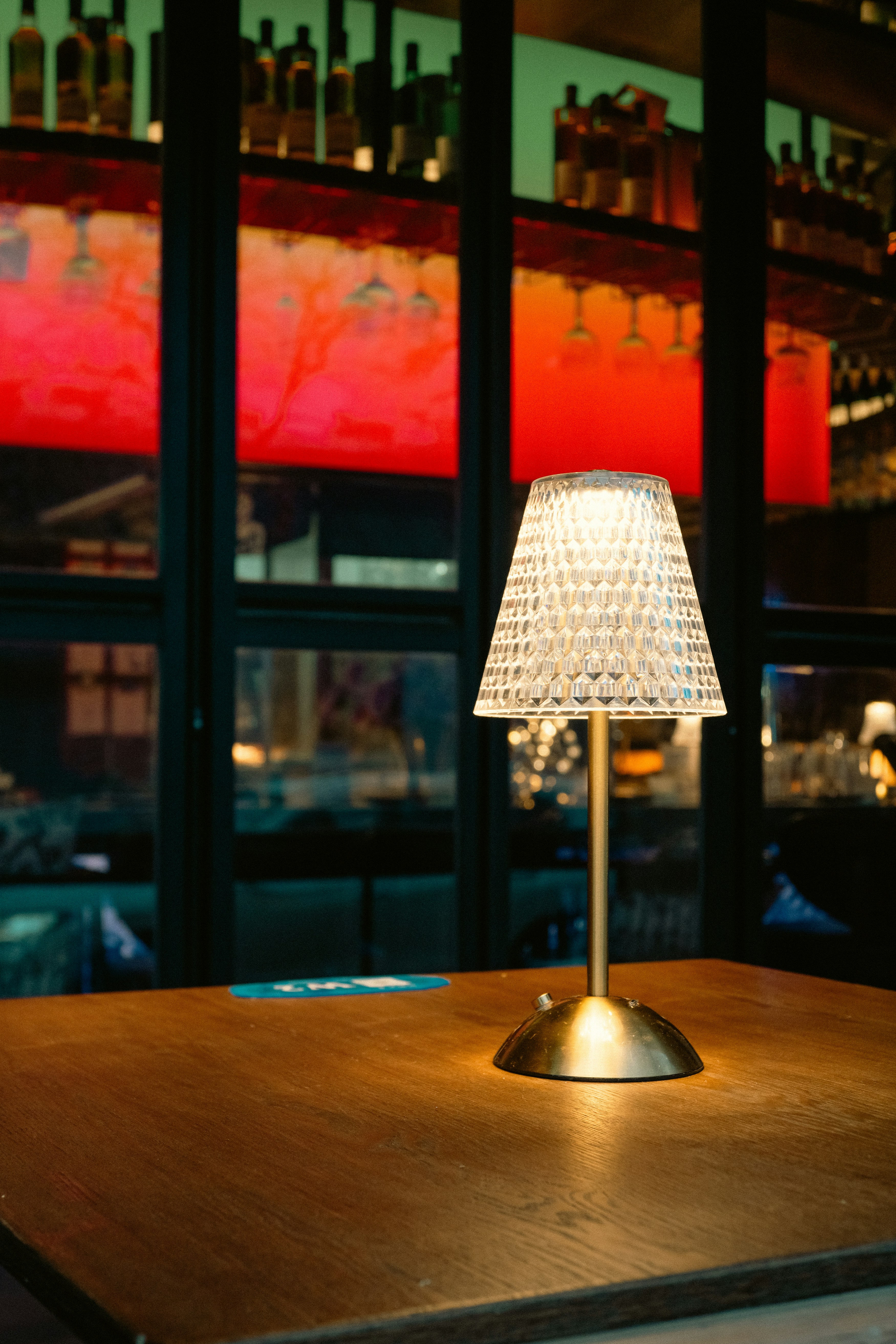 Ambient Glow: A Luminous Lamp Anchors a Quiet Bar Scene