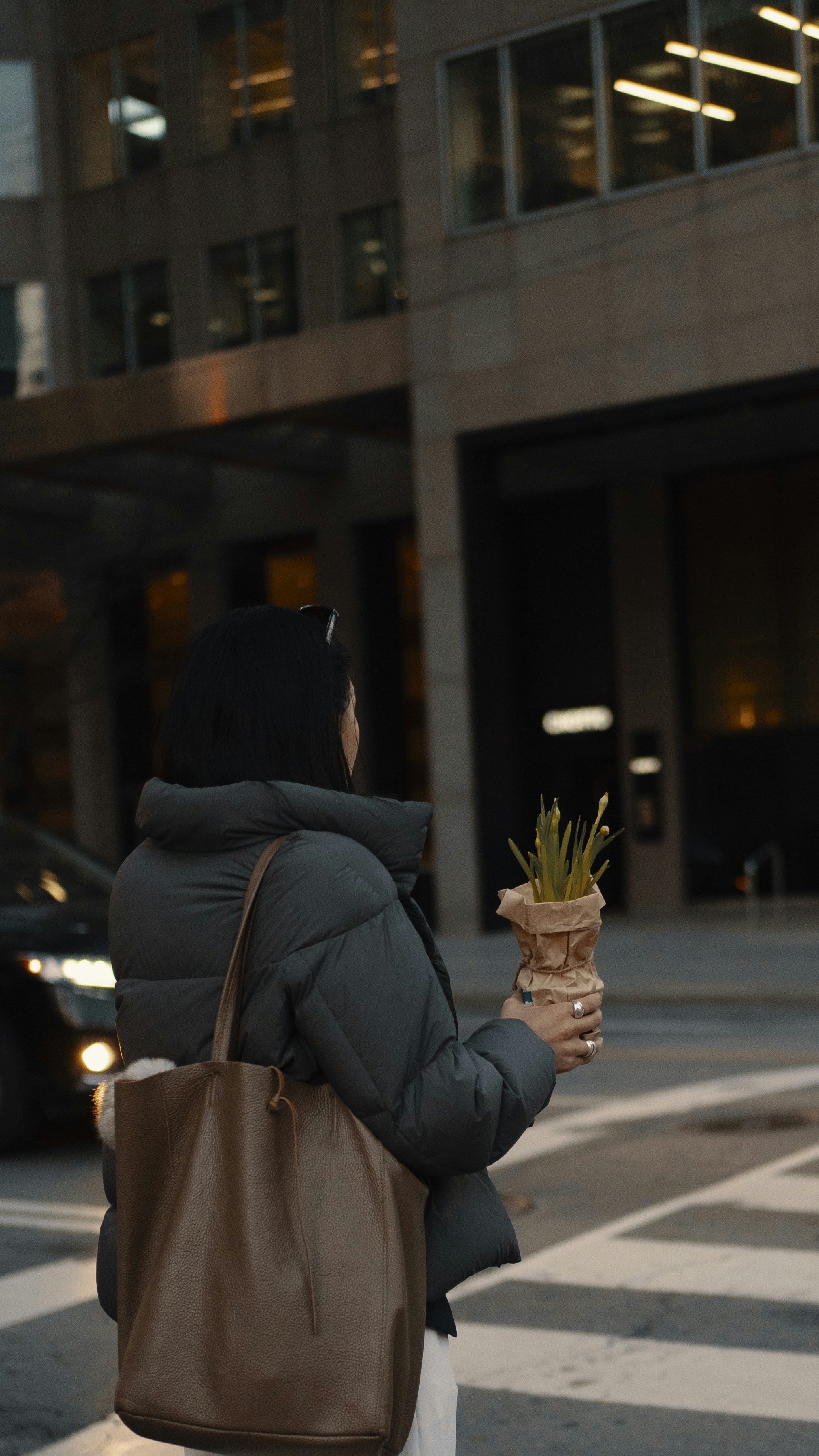 Urban Evening Behind-the-Back: A Woman with a Potted Bouquet