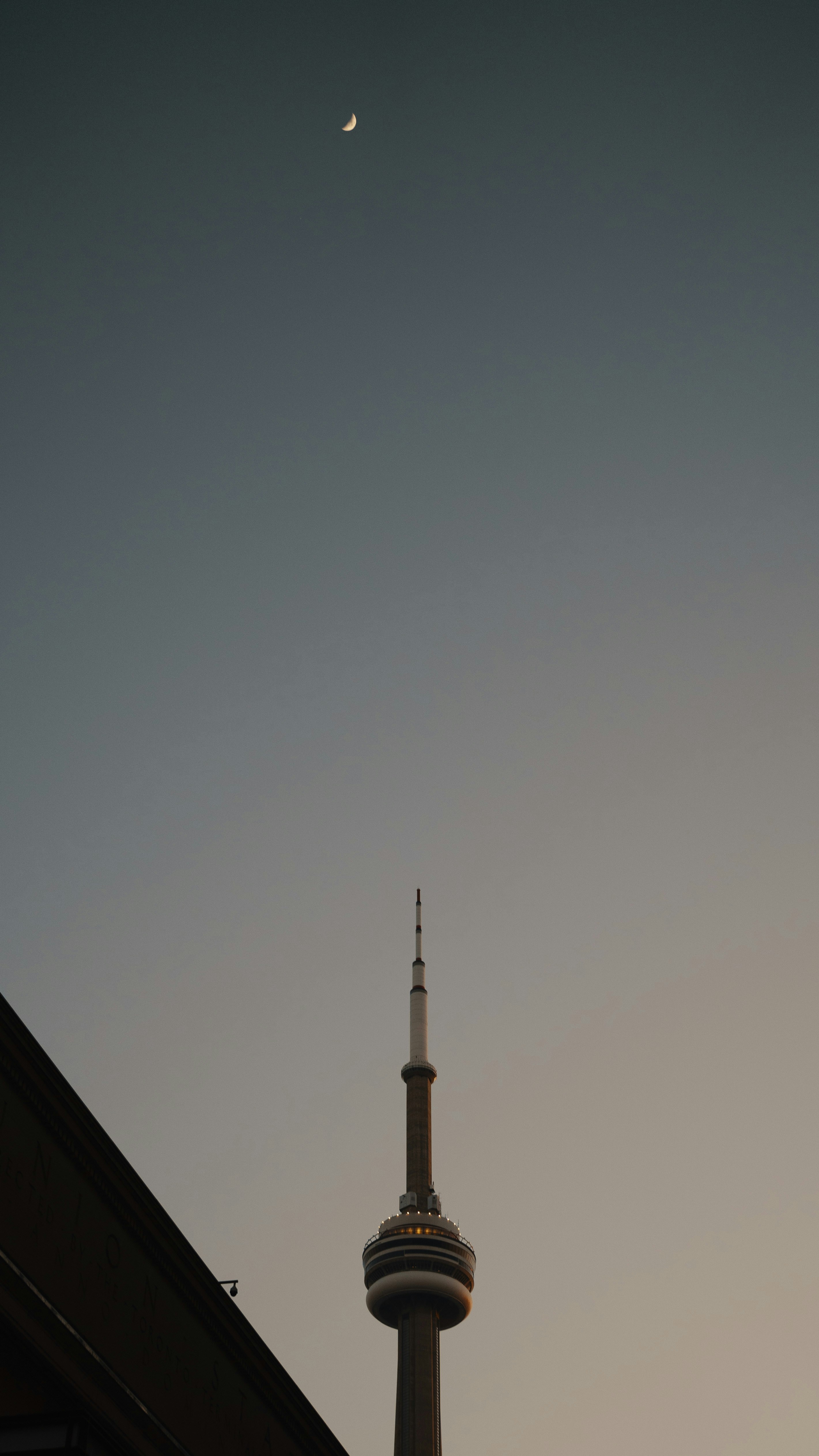 Moonlit Tip: Toronto’s Needle Reaches Skyward at Dusk